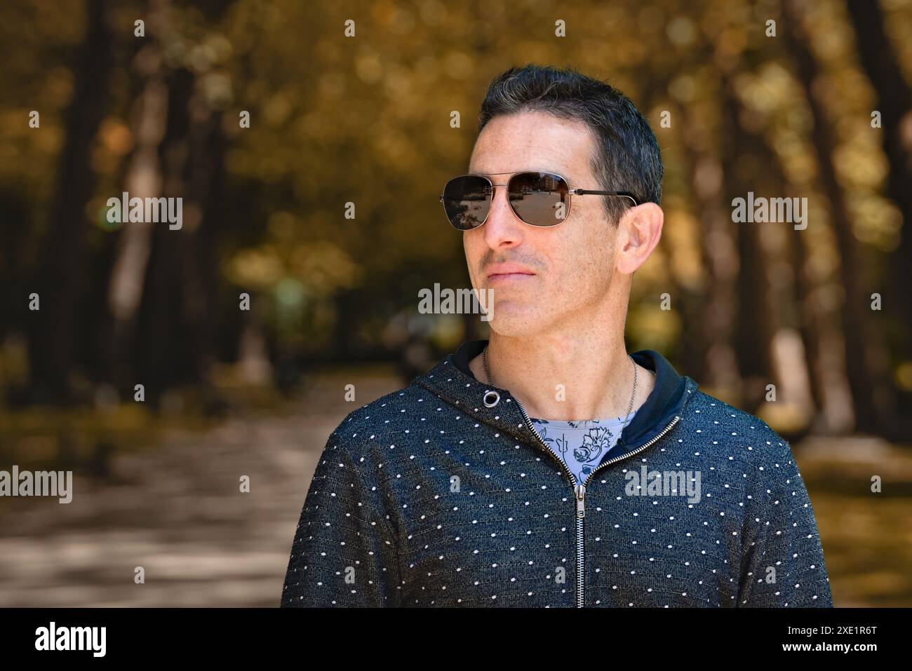 Mediterranean man in casual sports clothing and sunglasses, side ...