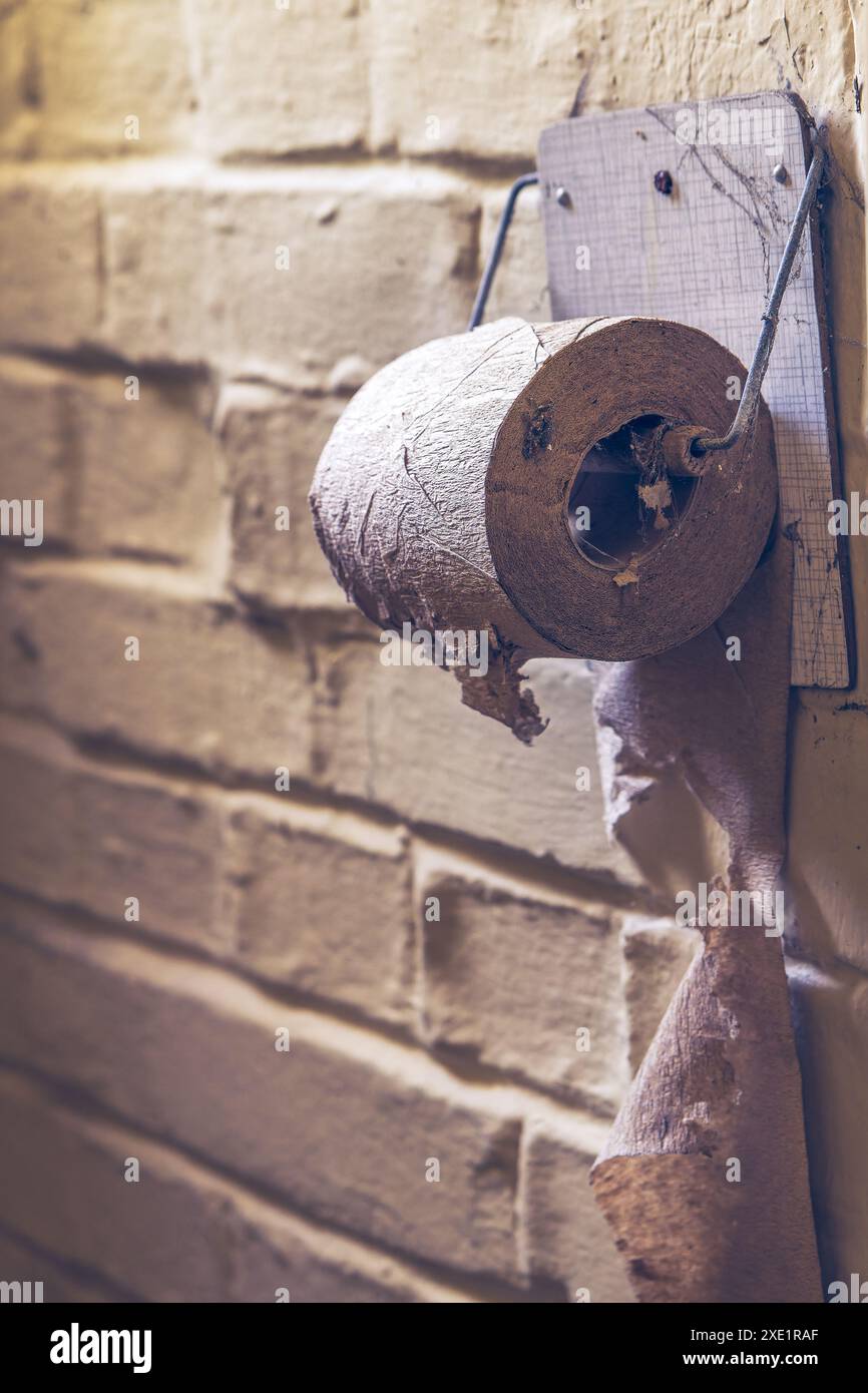 An old toilet paper holder in a dilapidated house Stock Photo - Alamy