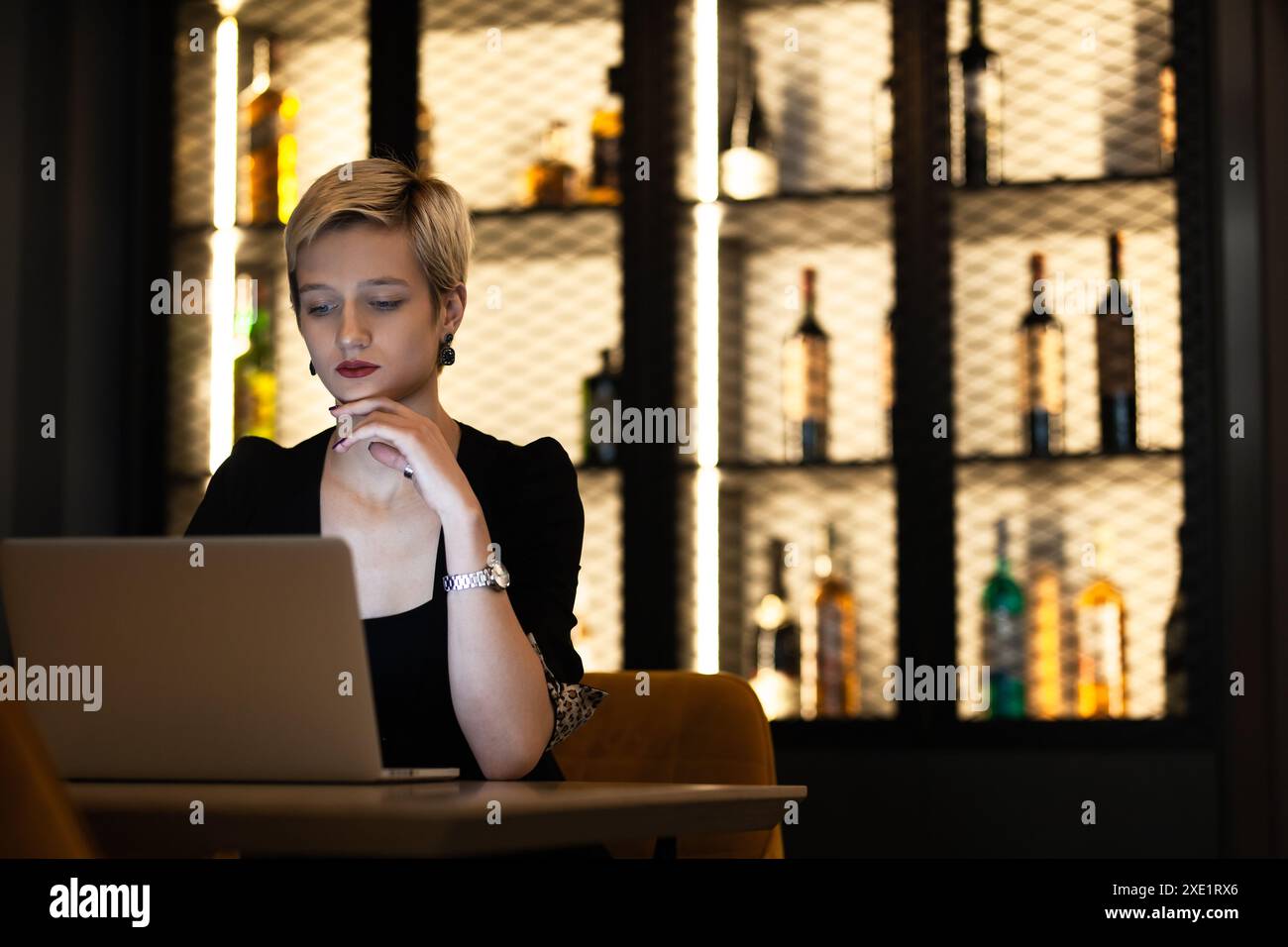 Young professional focusing intently on hi-res stock photography and ...
