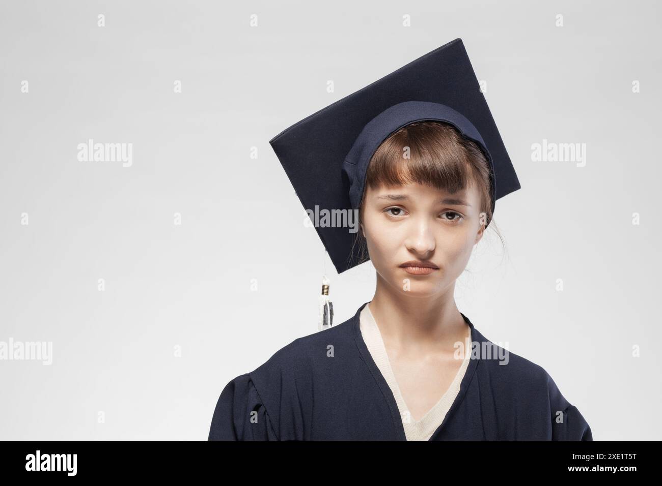 Graduation student portrait isolated on white background. Sad girl ...