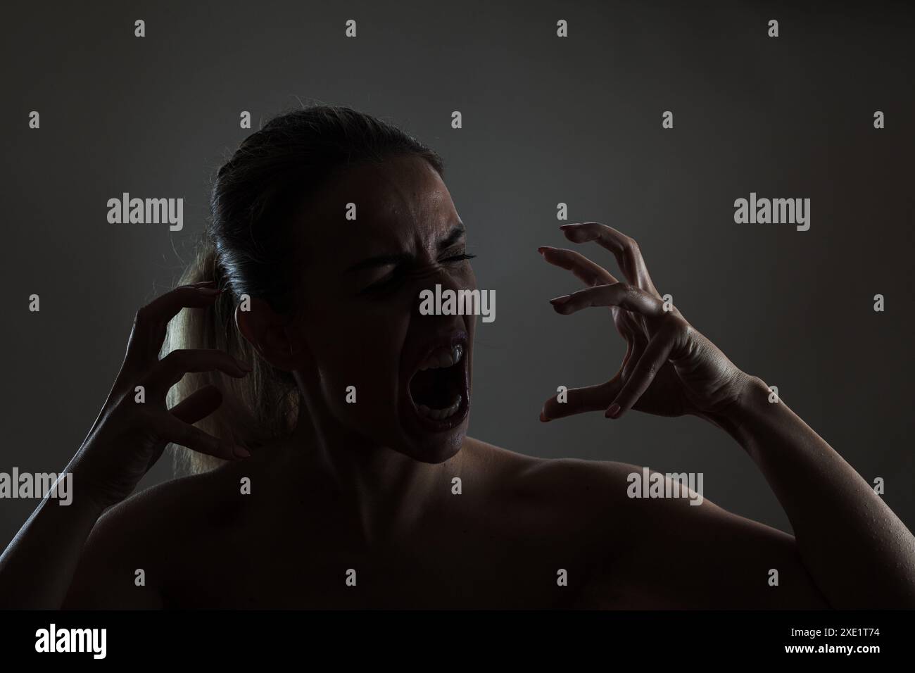 A moody and intense image capturing a young woman with an expression of ...