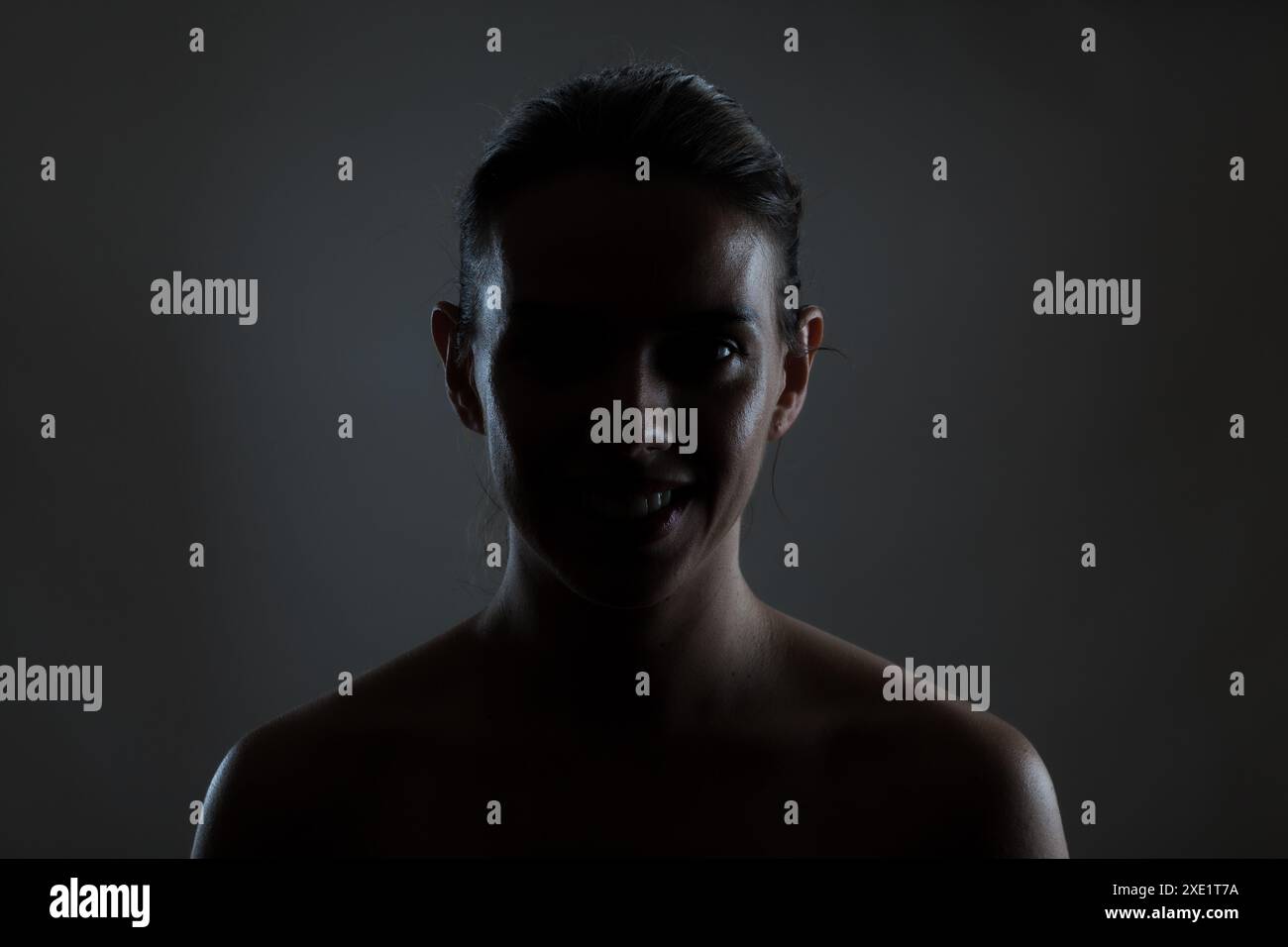 A portrait of a mysterious woman with a subtle smile, captured in low ...