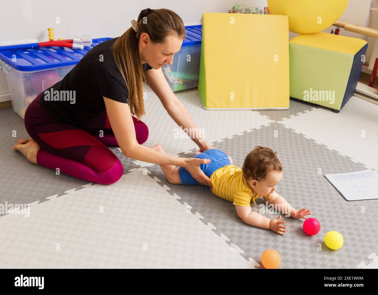 Birth trauma rehabilitation. Physical therapist helps infant with ...