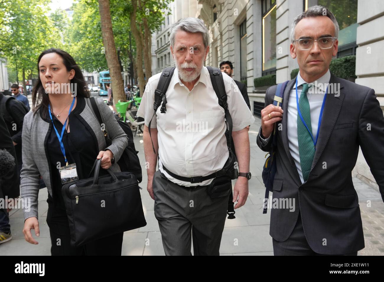Gareth Jenkins (centre), former engineer at Fujitsu Services Ltd leaves after giving evidence to ...