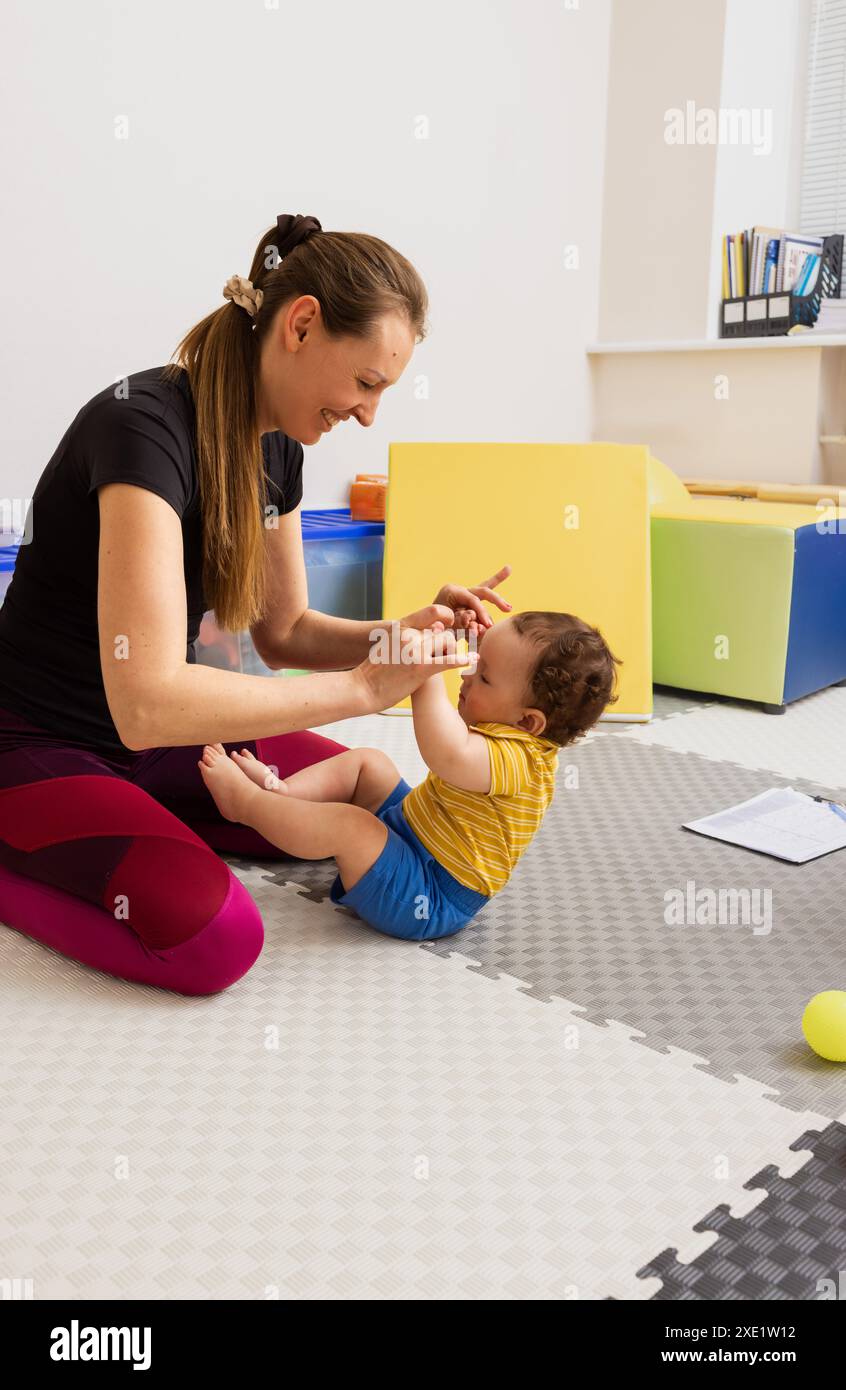 Little child while neurologic pediatric exam with arms traction ...