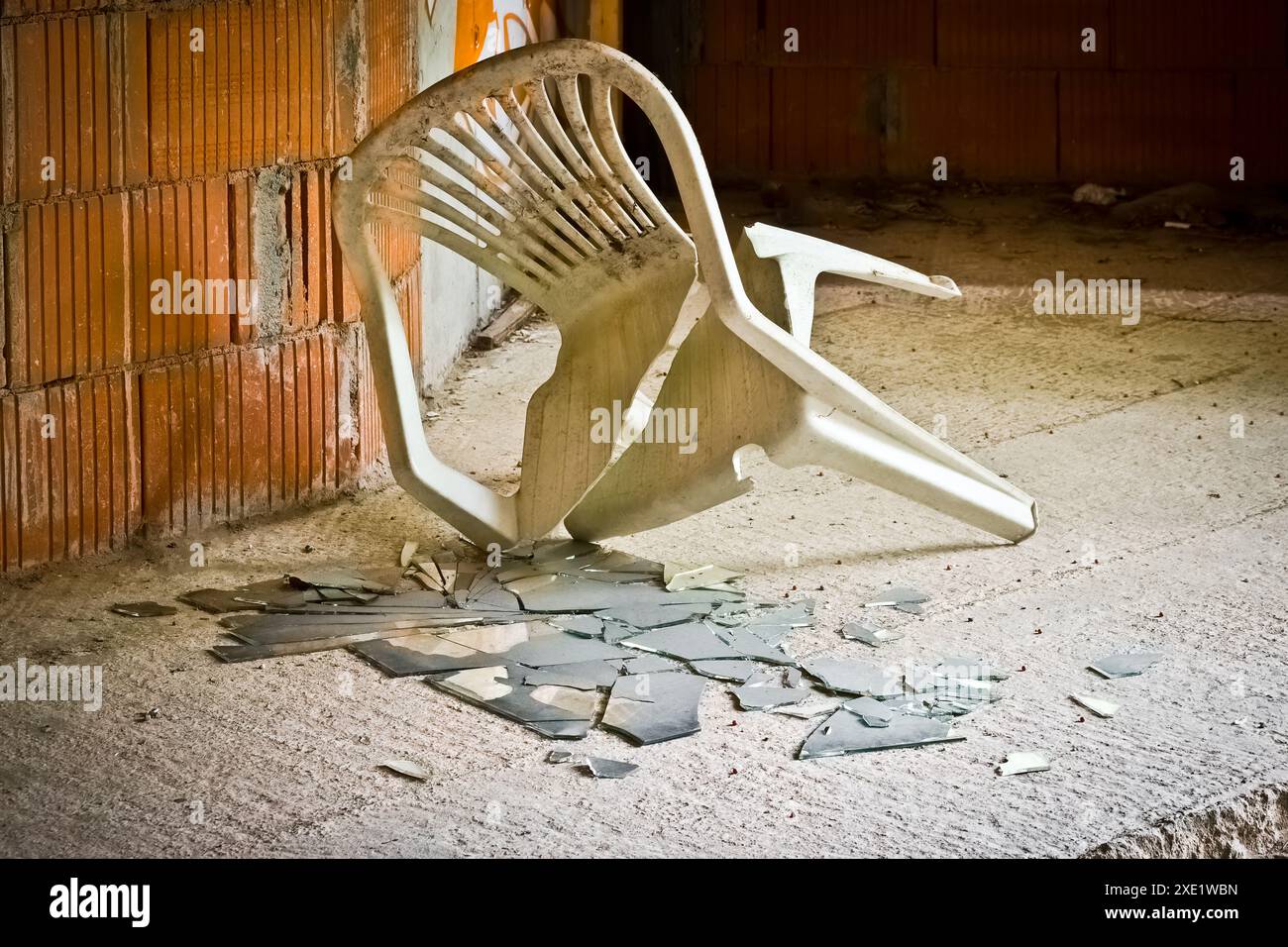 a broken garden chair in an unfinished house with trees in the ...