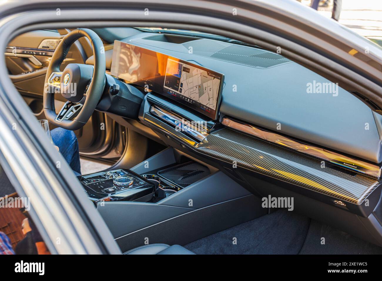 Gorgeous passenger-side view of interior of new BMW i5 M electric car with carbon fiber ...