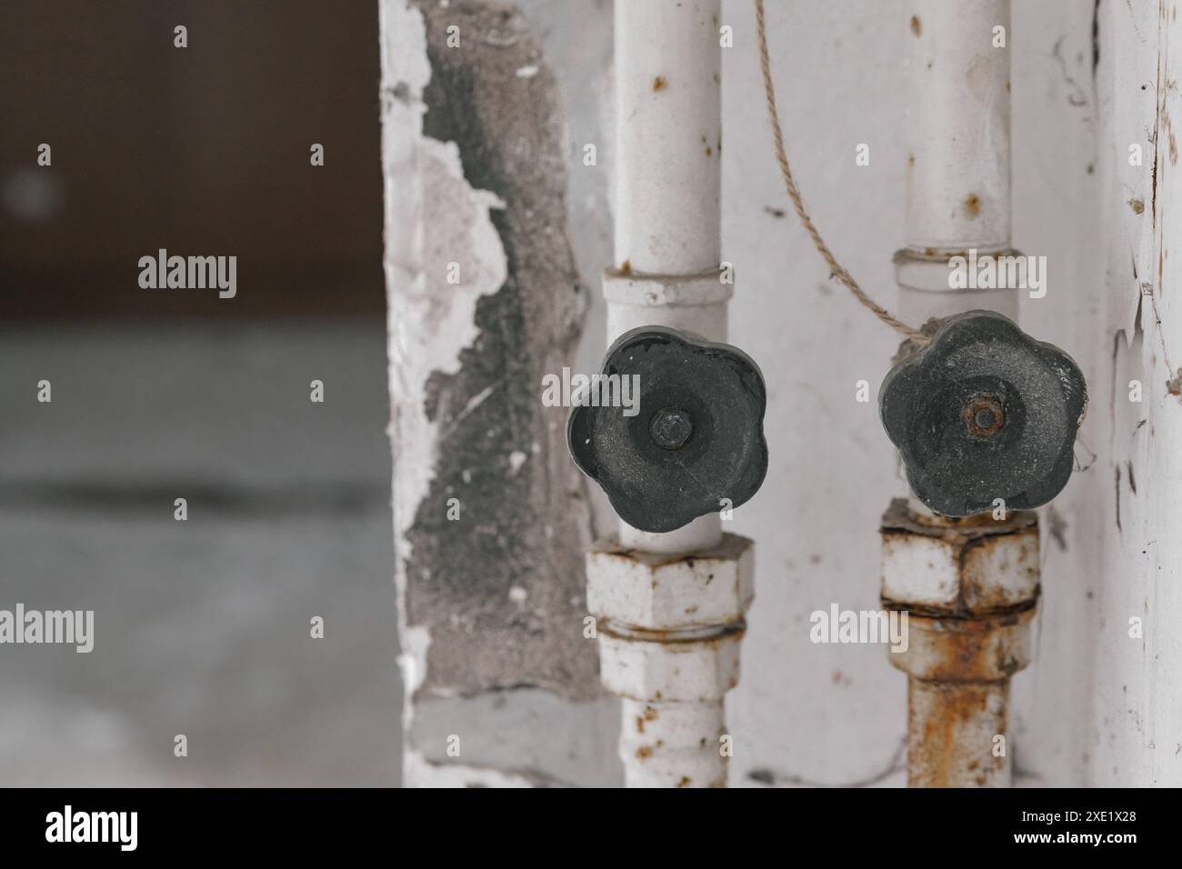 Old heating pipes with rotary valve Stock Photo - Alamy
