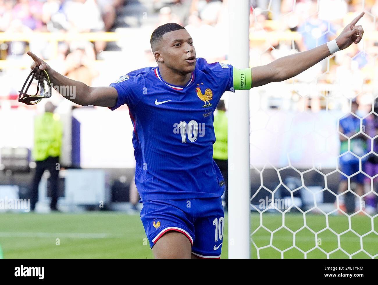 France's Kylian Mbappe takes off his protective face mask and ...