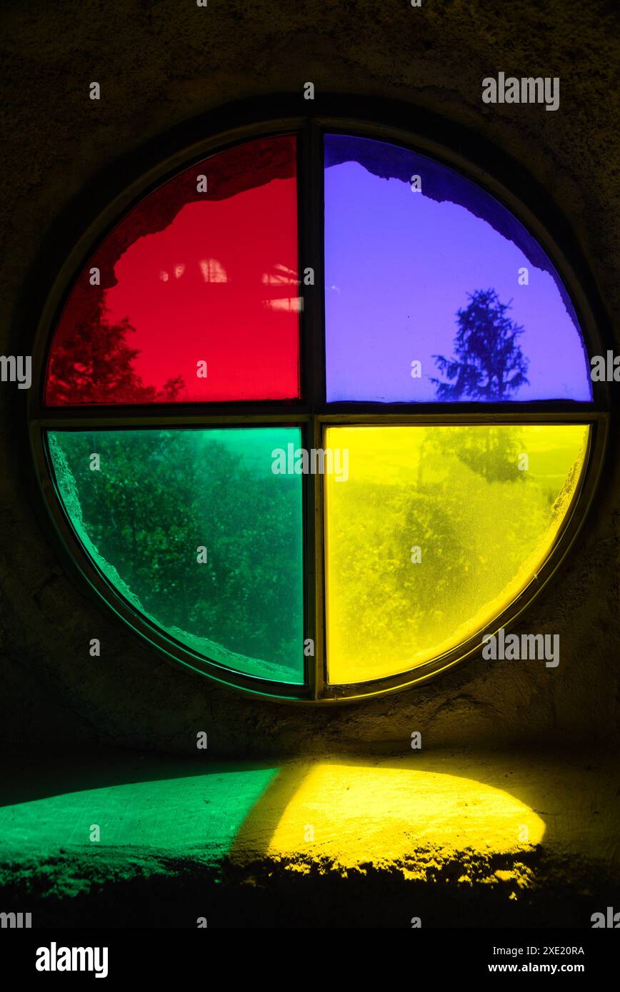 Old round window with four bright colors in old building - color window ...