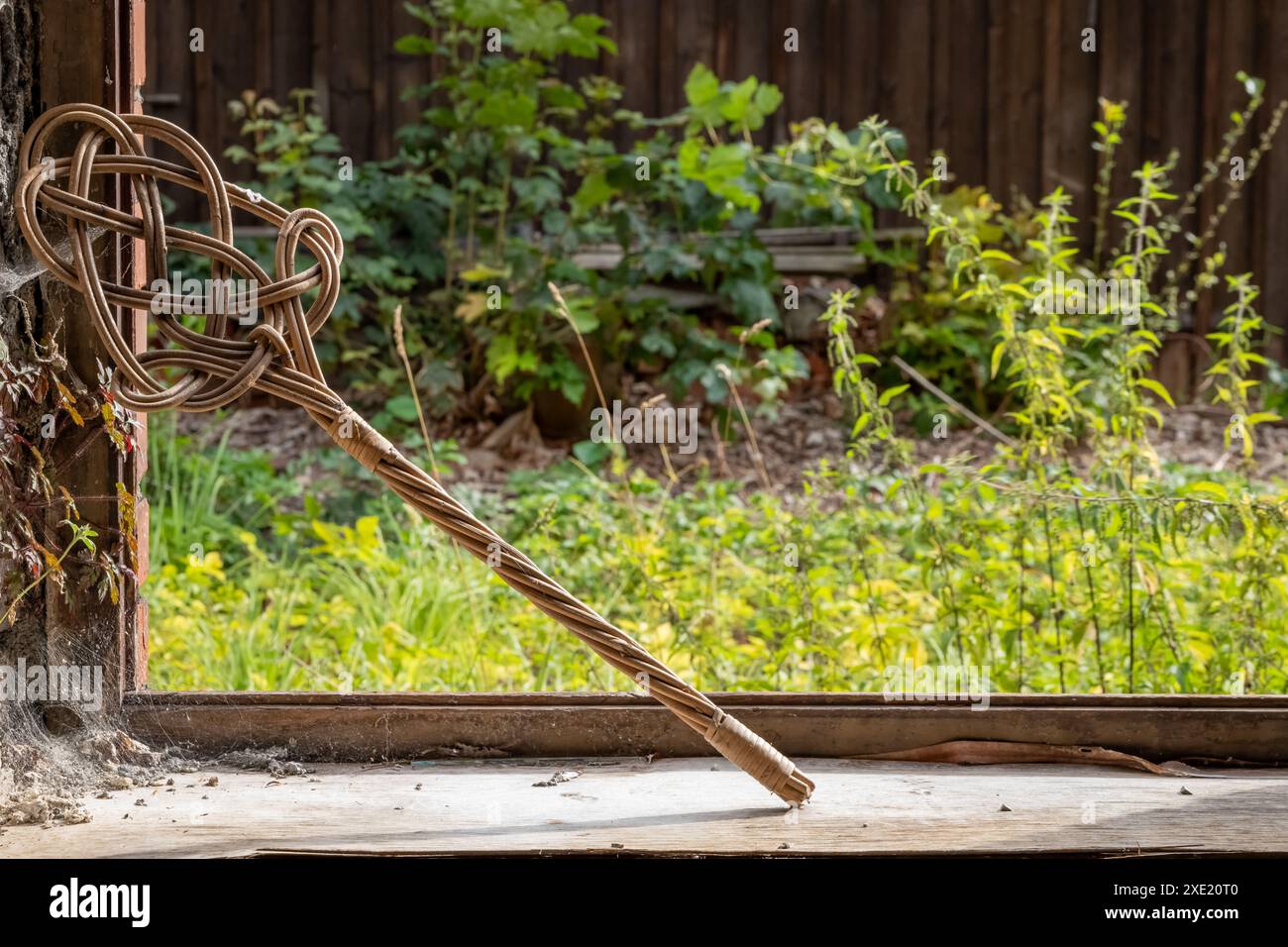 An old carpet beater on a window in a lost place Stock Photo - Alamy
