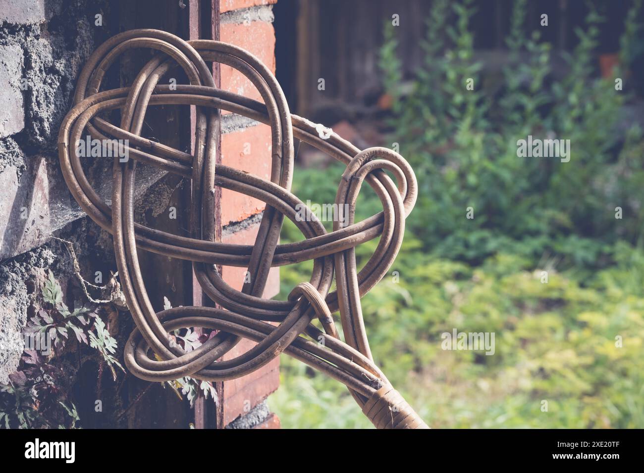 An old carpet beater on a window in a lost place Stock Photo - Alamy