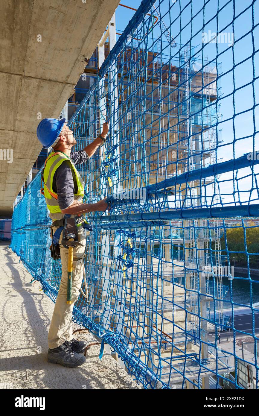 Worker placing Security System Work RESA. Protection in building work ...