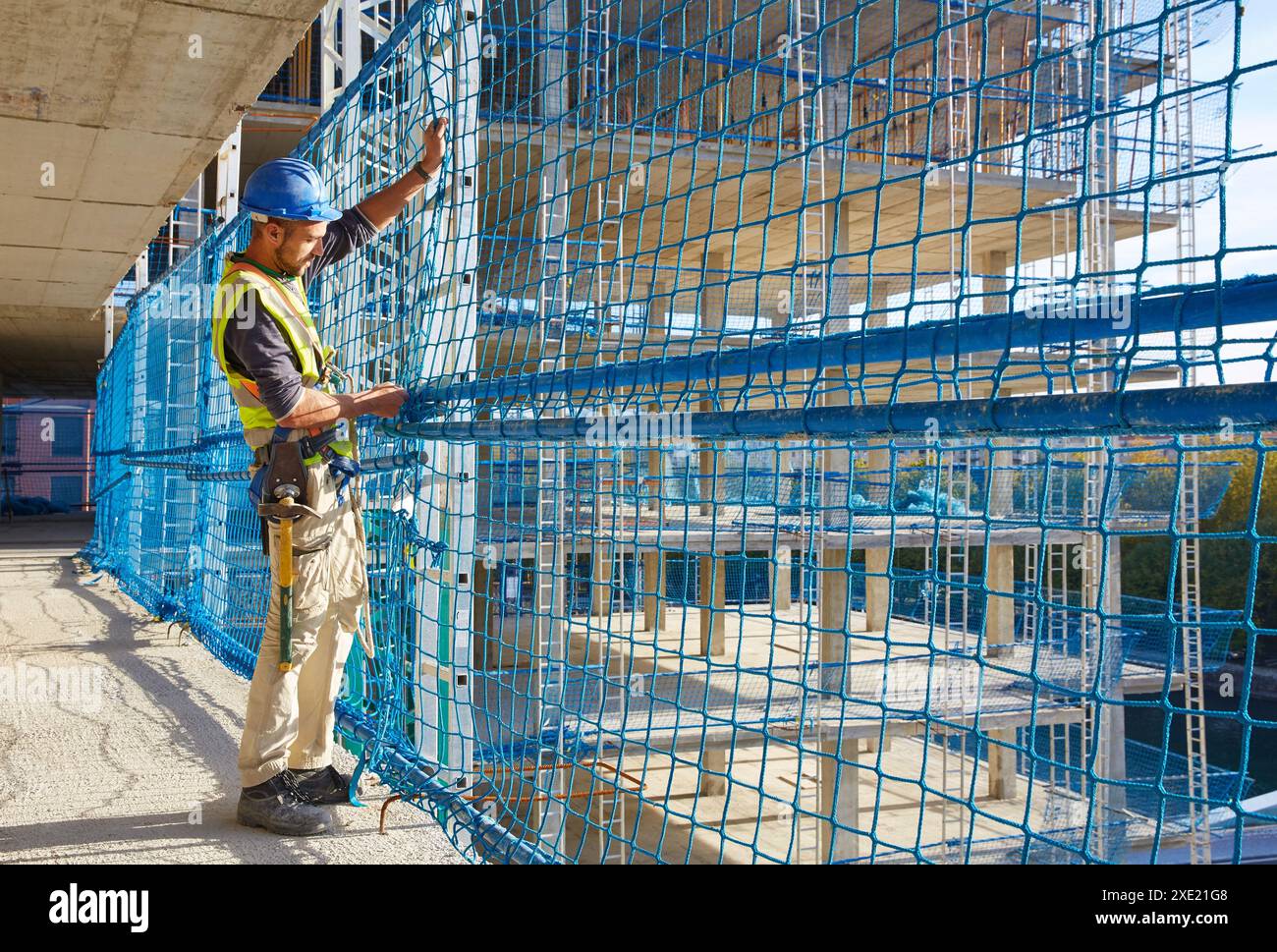Worker placing Security System Work RESA. Protection in building work ...