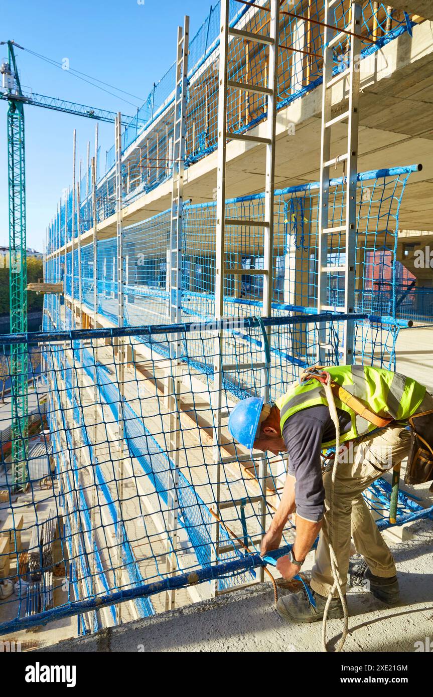 Worker placing Security System Work RESA. Protection in building work ...