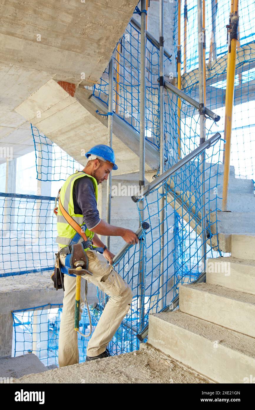 Worker placing Security System Work RESA. Protection in building work ...