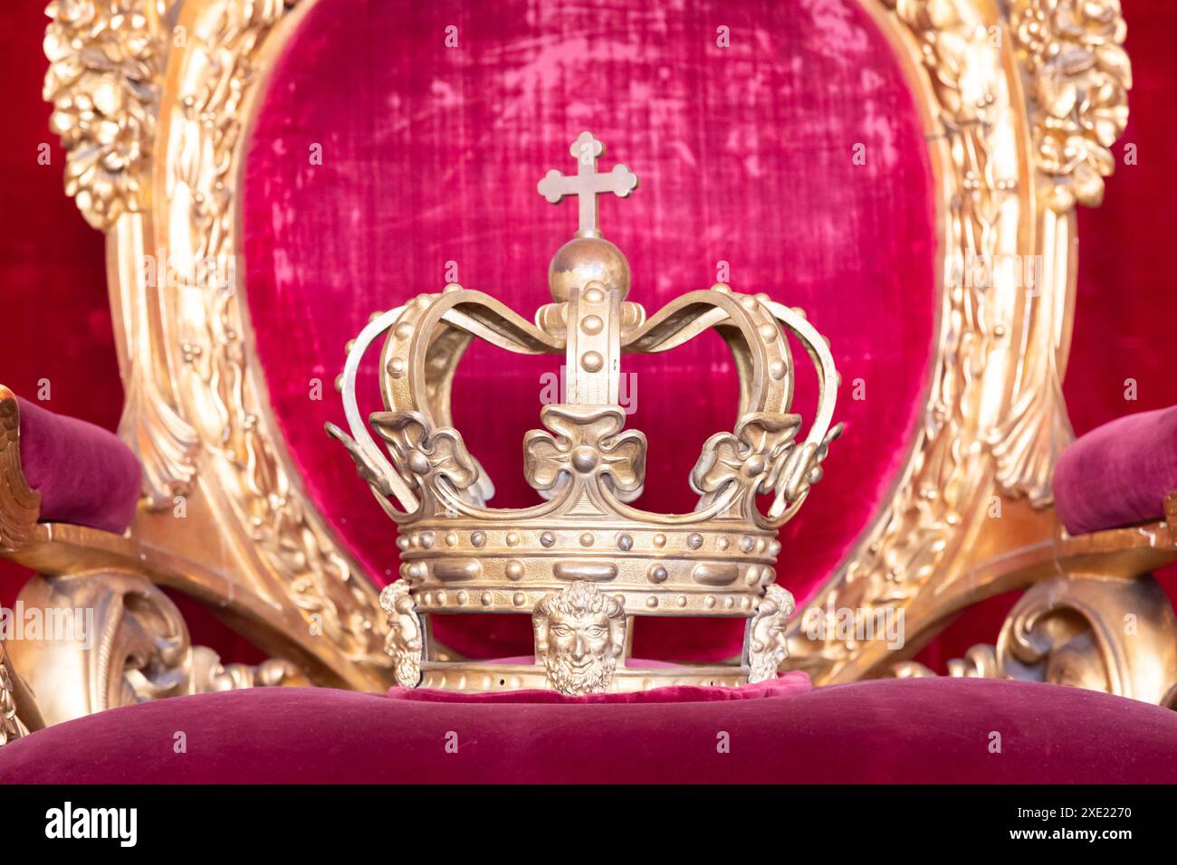 Ancient crown on red velvet. Antique symbol of authority, luxury ...