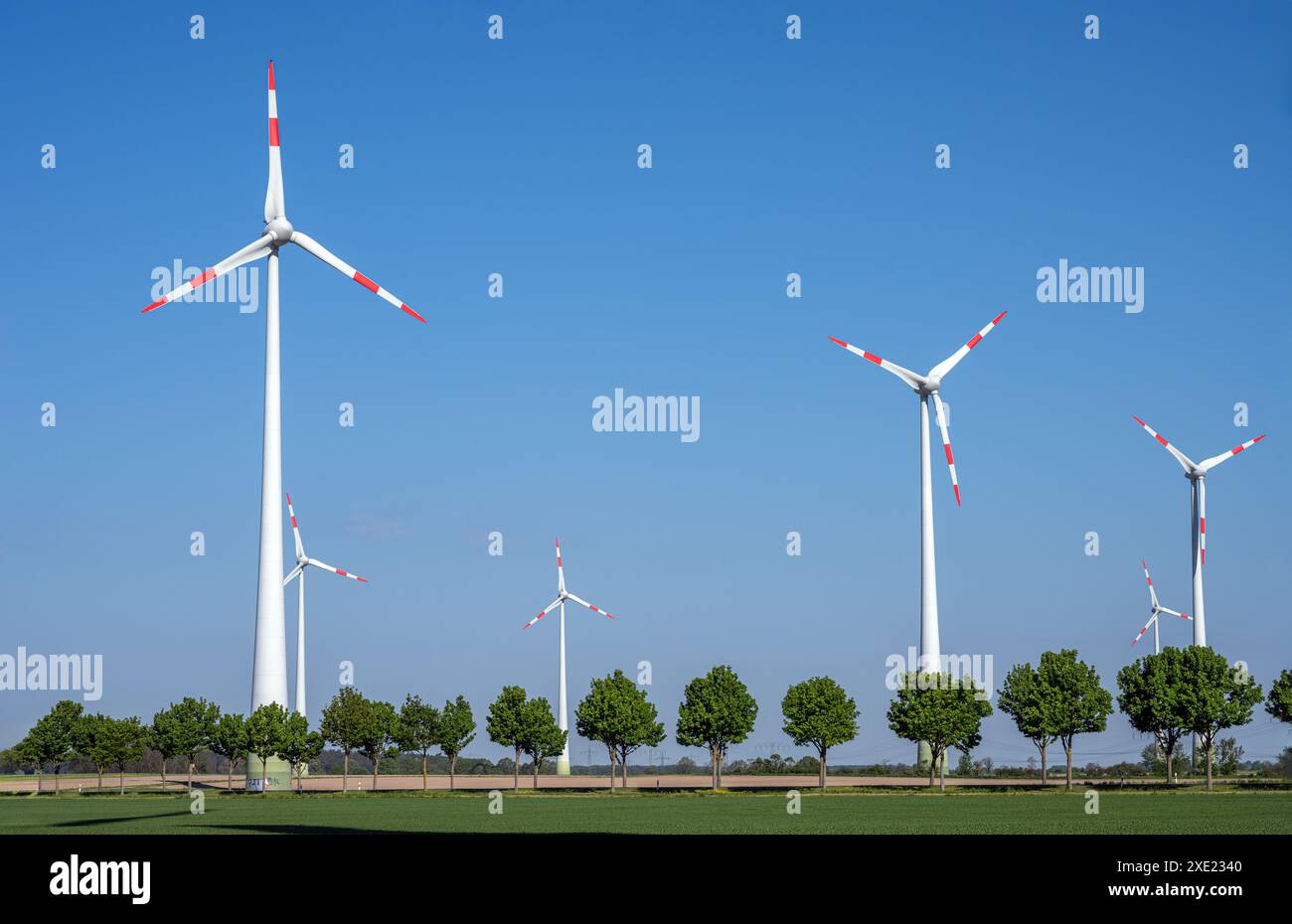 Modern wind turbines with a tree-lined road seen in Germany Stock Photo ...