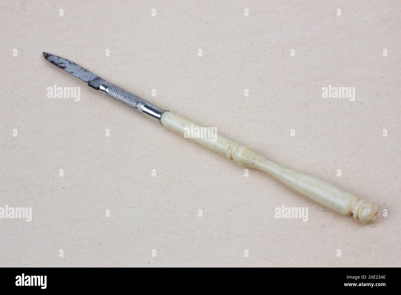 Retro envelope opener knife on paper background Stock Photo - Alamy