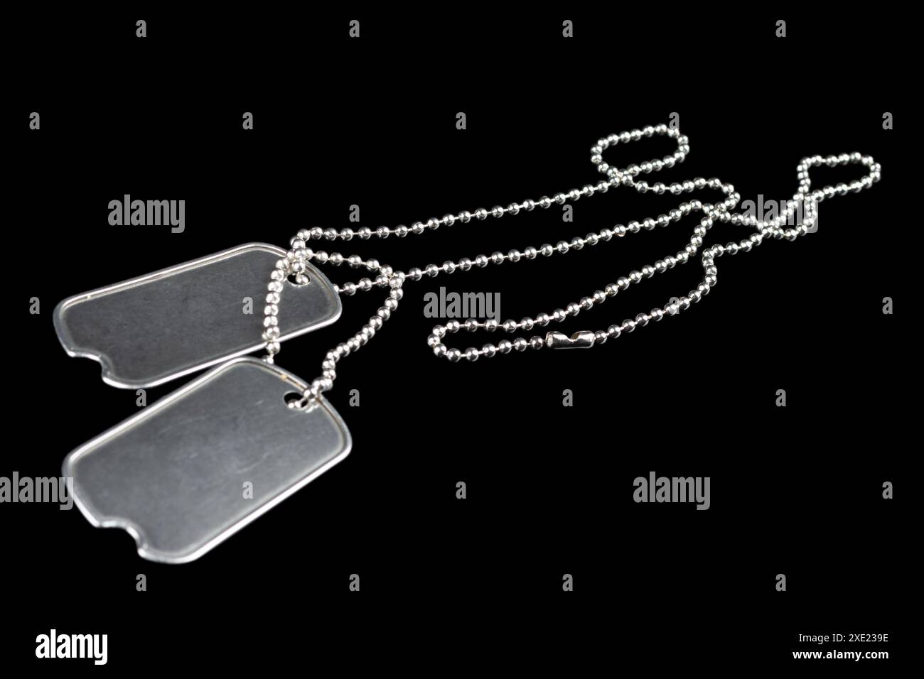 US army dog tags on black background Stock Photo - Alamy