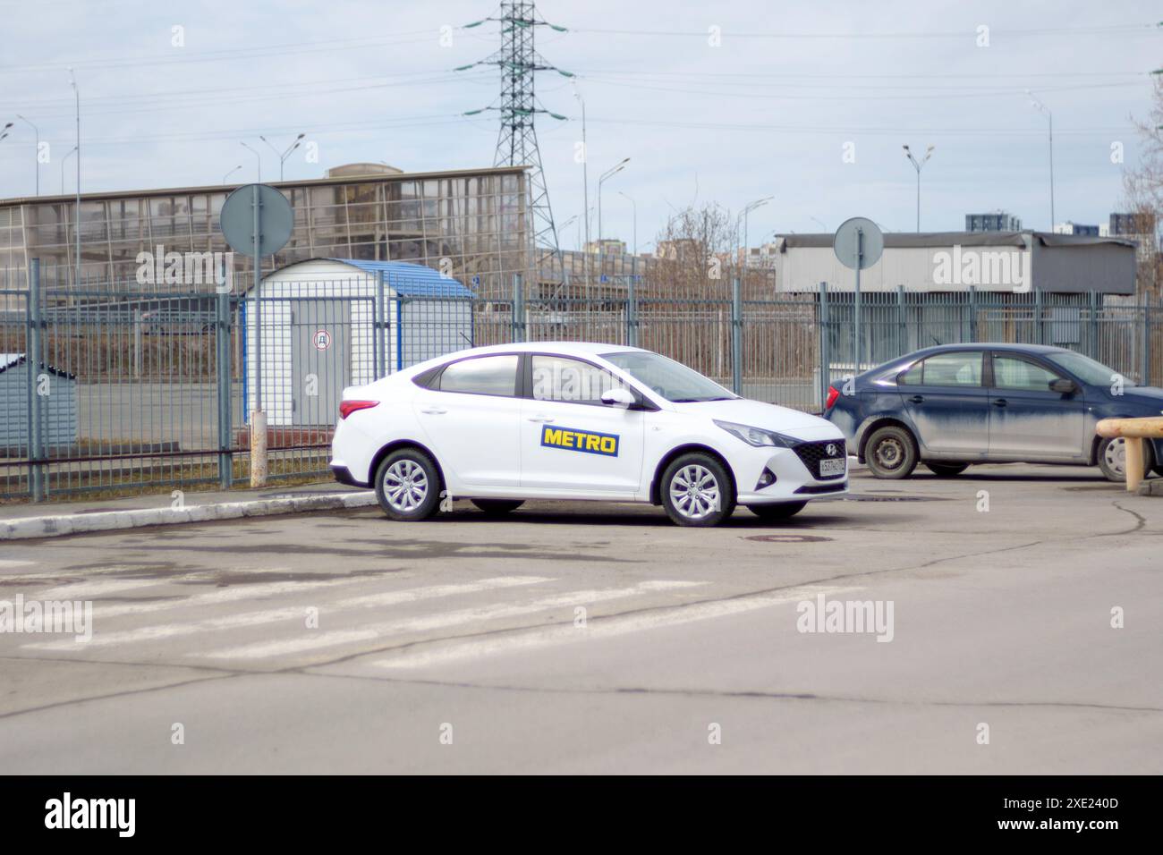 Tyumen, Russia-March 02, 2024: Metro logo on a white car. Metro cash ...