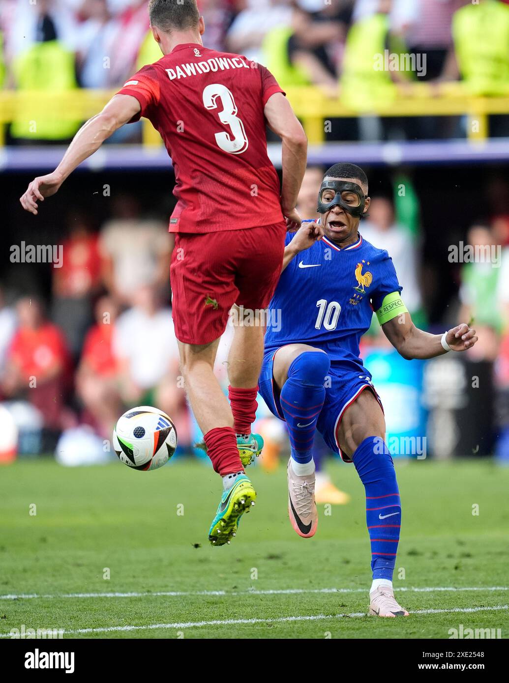 France's Kylian Mbappe (right) and Poland's Pawel Dawidowicz battle for ...