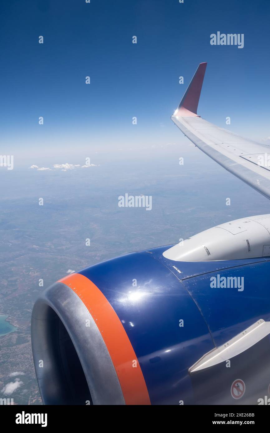 Airplane flight. Wing of an airplane flying above the clouds. View from ...