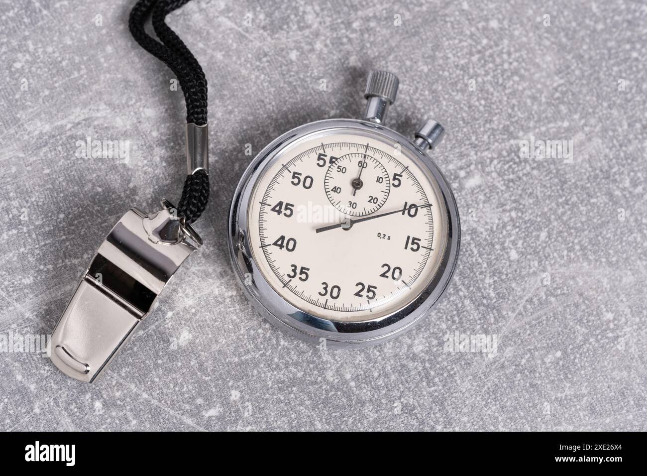 Vintage stopwatch with whistle on gray background. Sports concept Stock ...