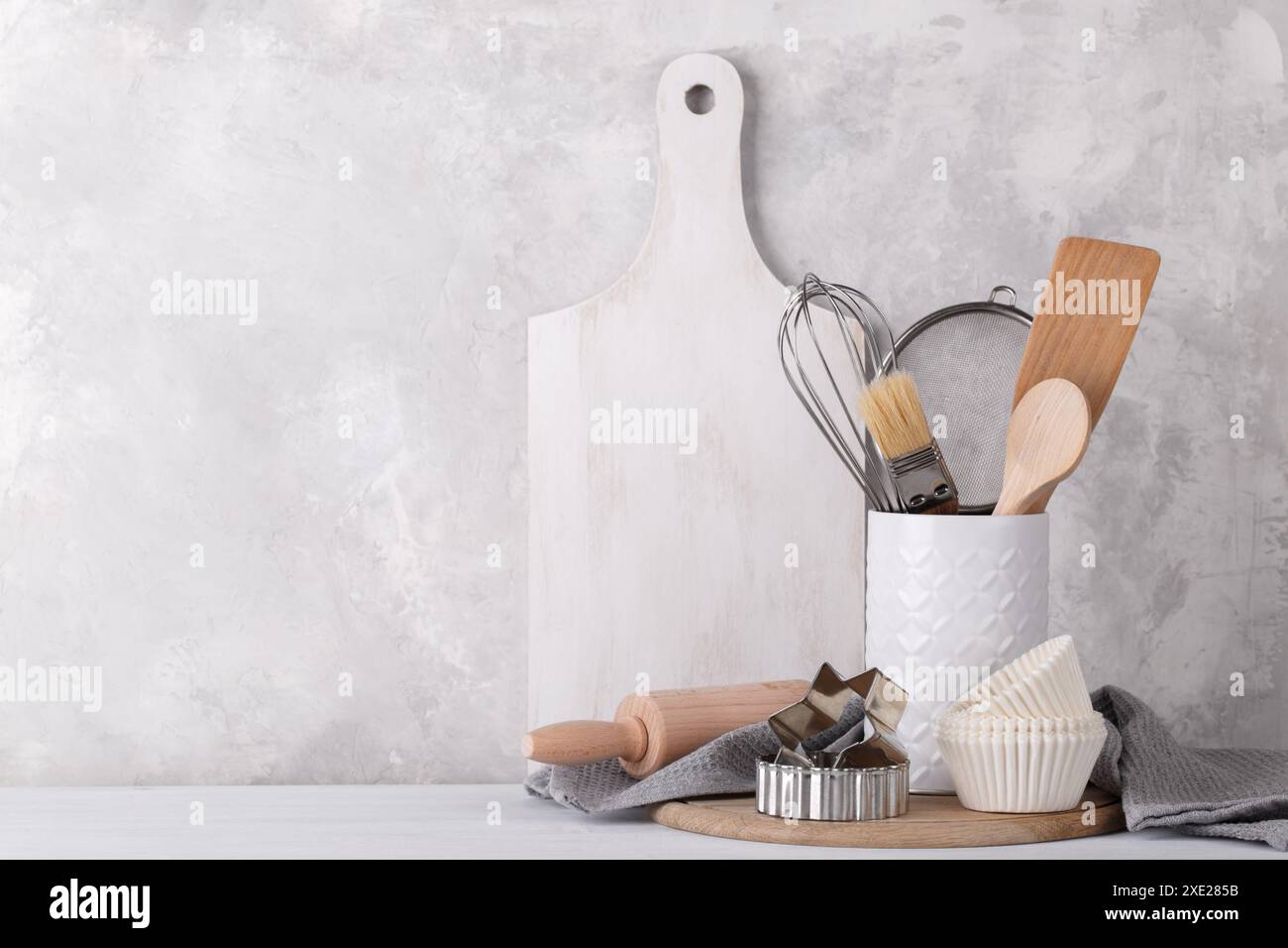 Kitchen shelf with white modern ceramic and wooden dishware against ...
