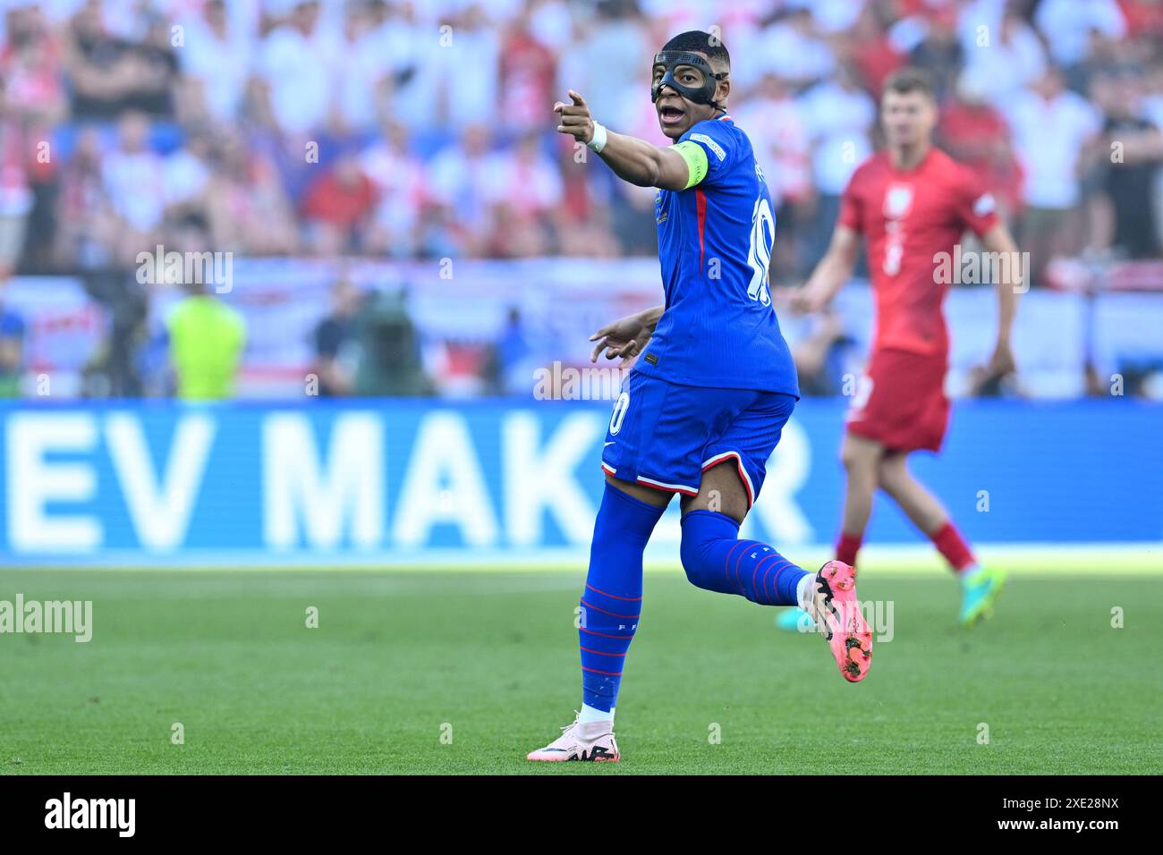 Kylian Mbappe (10) of France playing with a black facemask to protect his broken nose during a ...