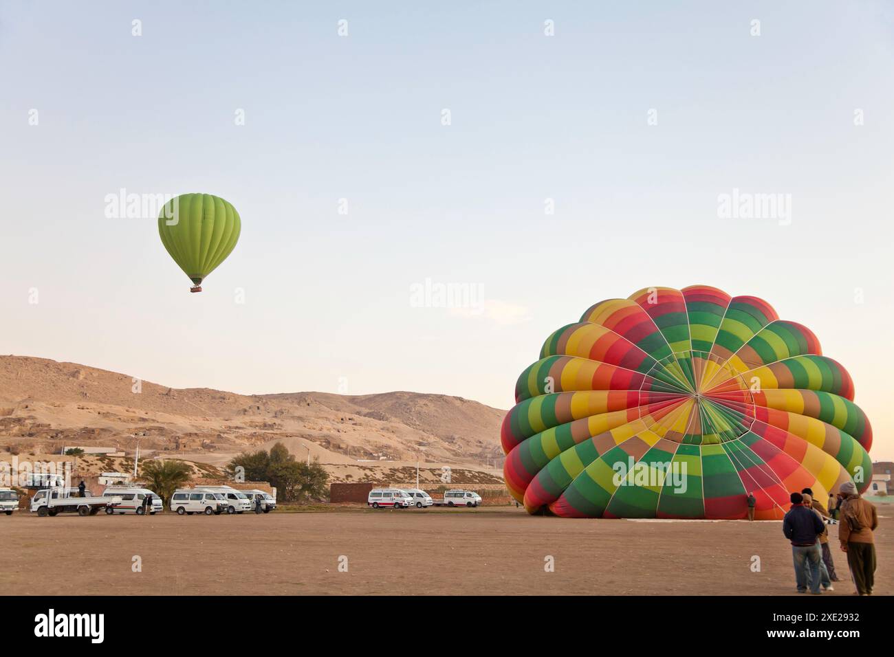 View of hot air balloon at the field in front of Valley of the Kings ...