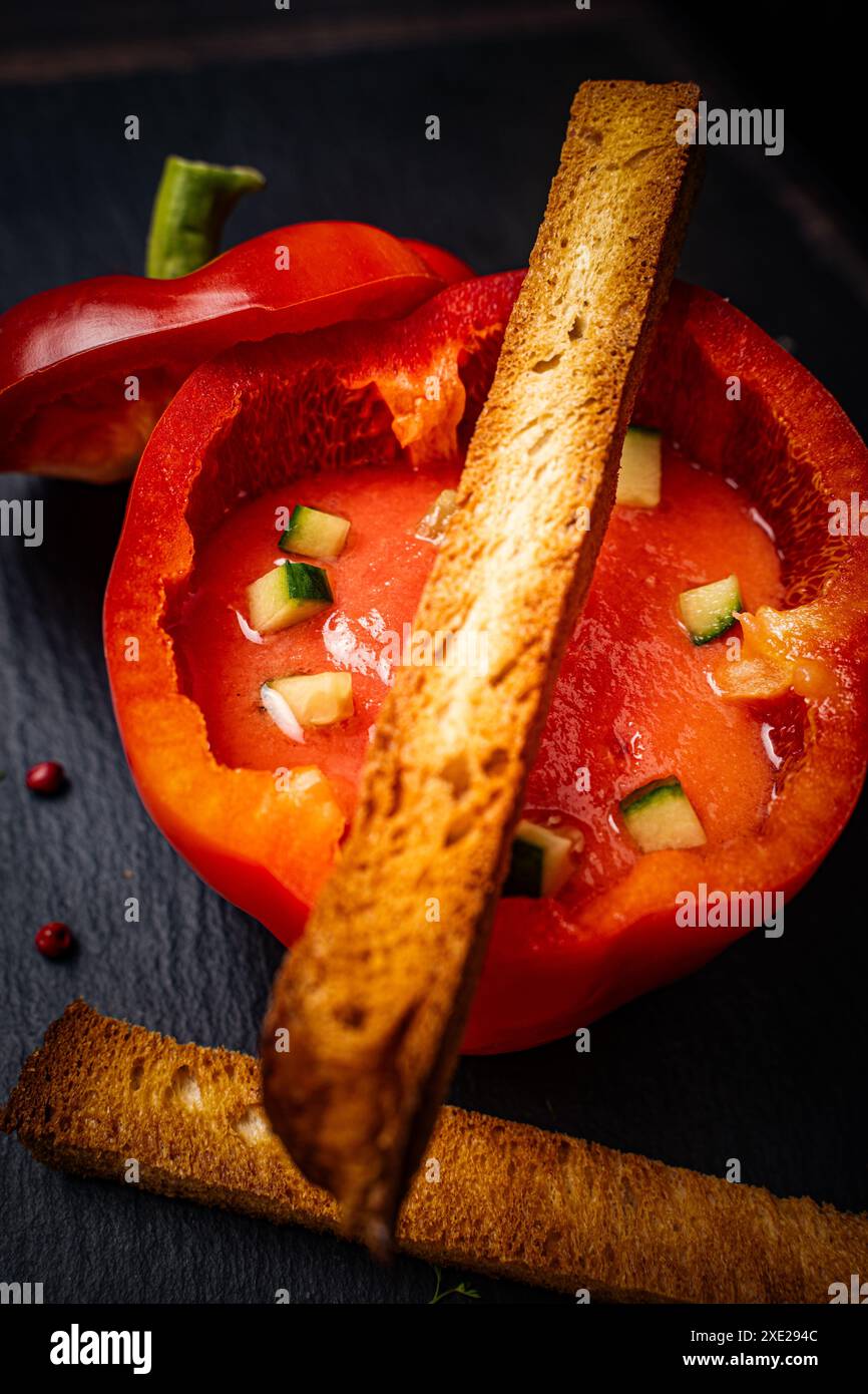 Tomato gazpacho soup in red bell peppers with cucumber and dried bread ...