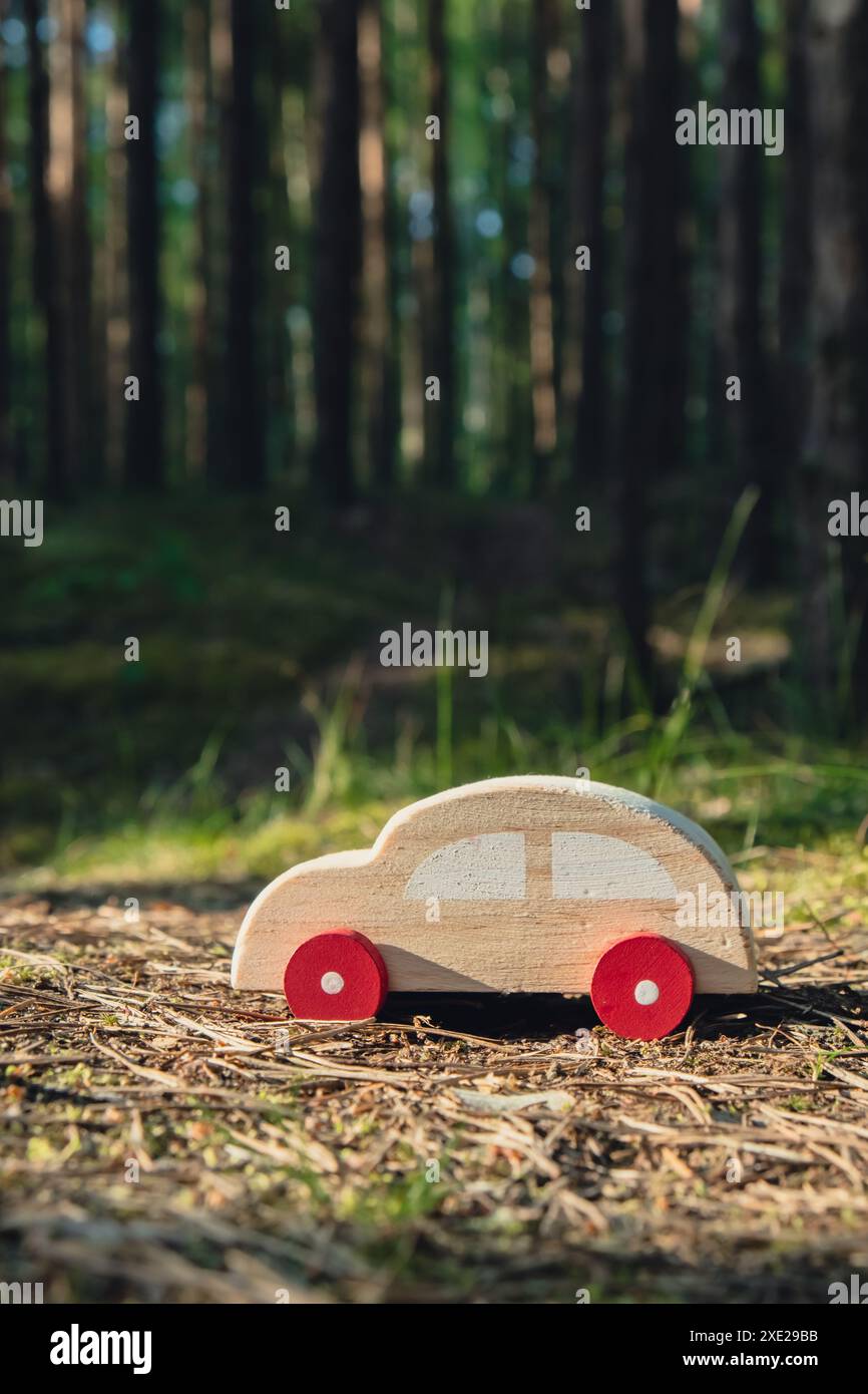 Wooden toy car on greenery forest background. Eco-car concept World car ...