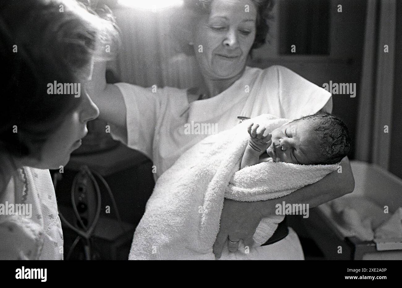 1970s, historical, maternity nurse showing a mother new newly born ...