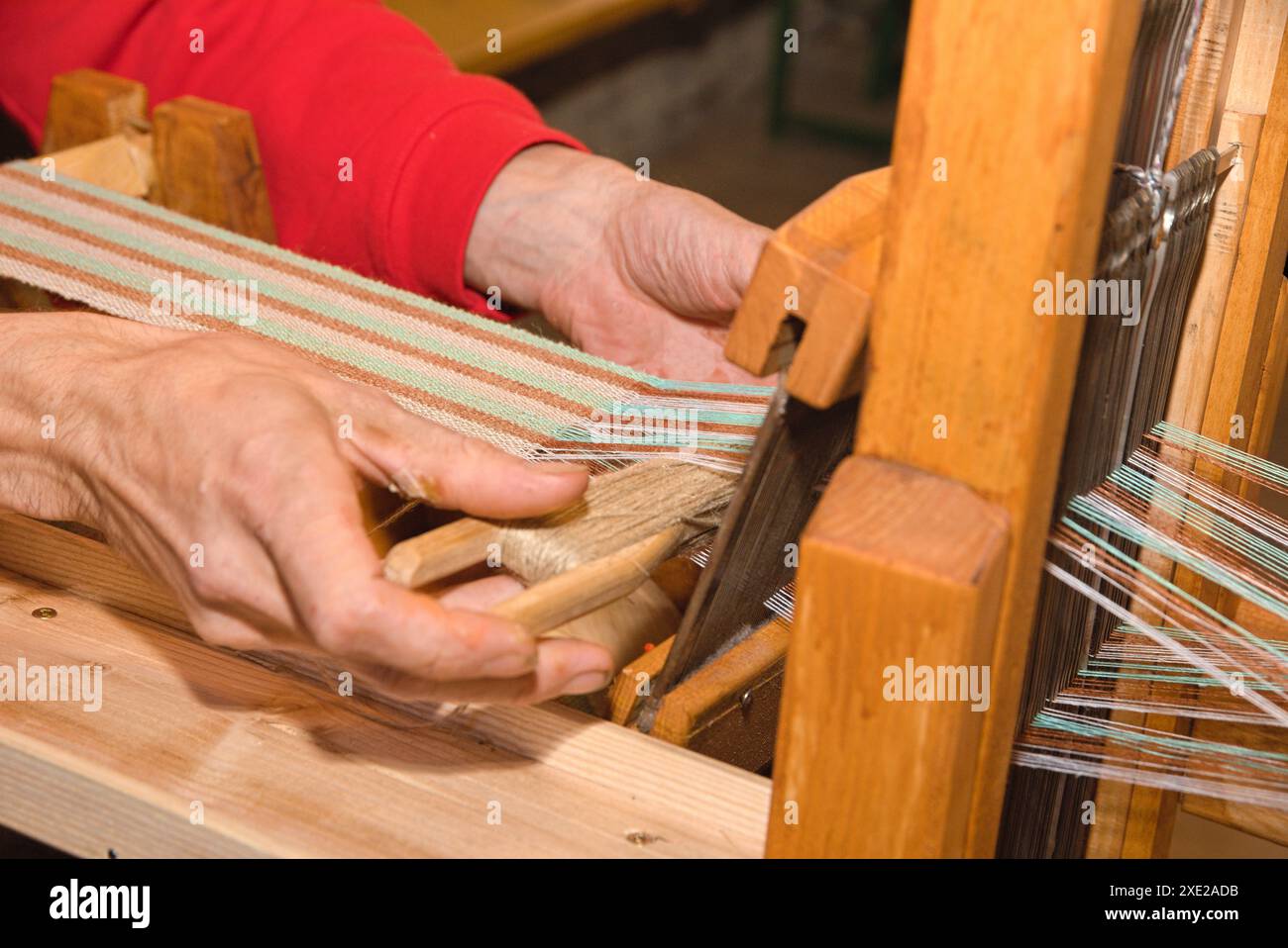 Person weaving fabric using wooden table loom Stock Photo - Alamy