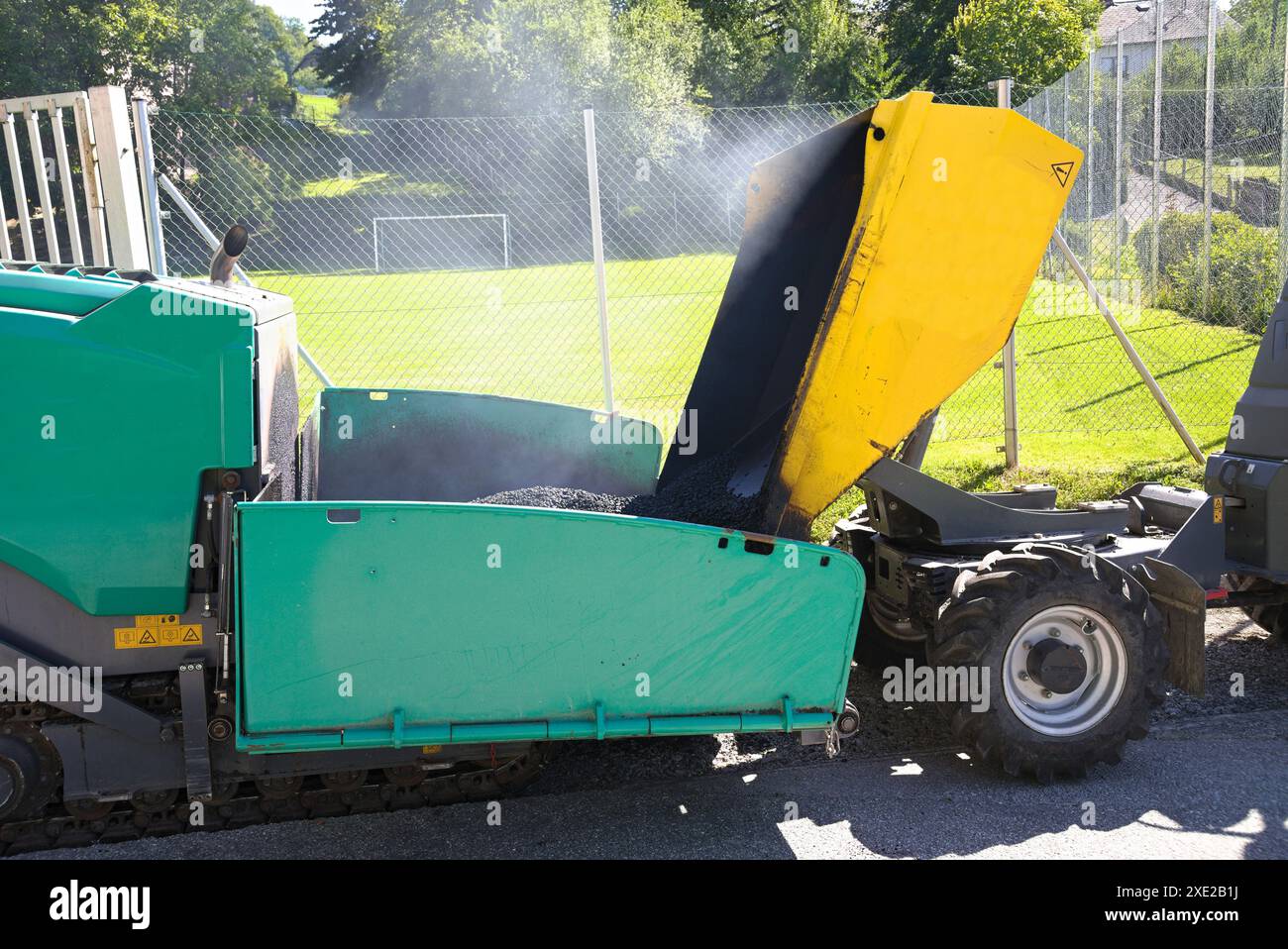 Asphalting with special vehicle pavers and dumpers and dump trucks ...