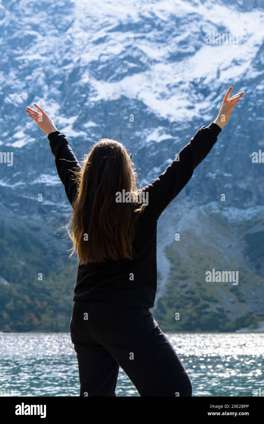 Young woman enjoying nature in Morskie Oko Snowy Mountain Hut in Polish ...