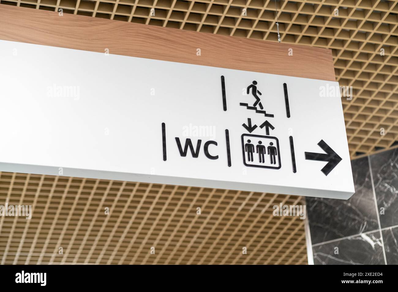 An information sign indicates directions to the toilet and stairs Stock ...