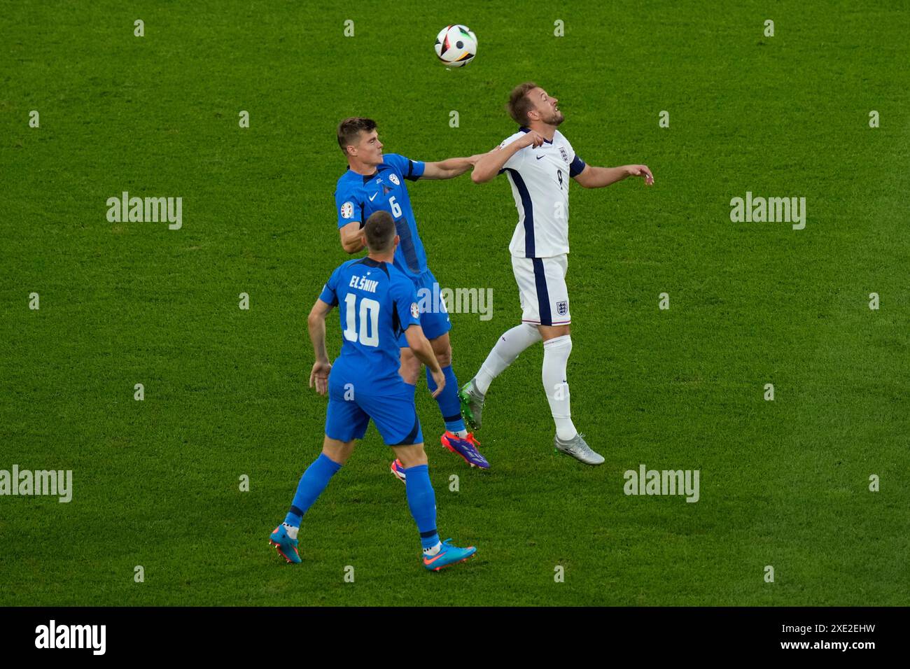 England's Harry Kane, right, heads the ball over Slovenia's Jaka Bijol ...