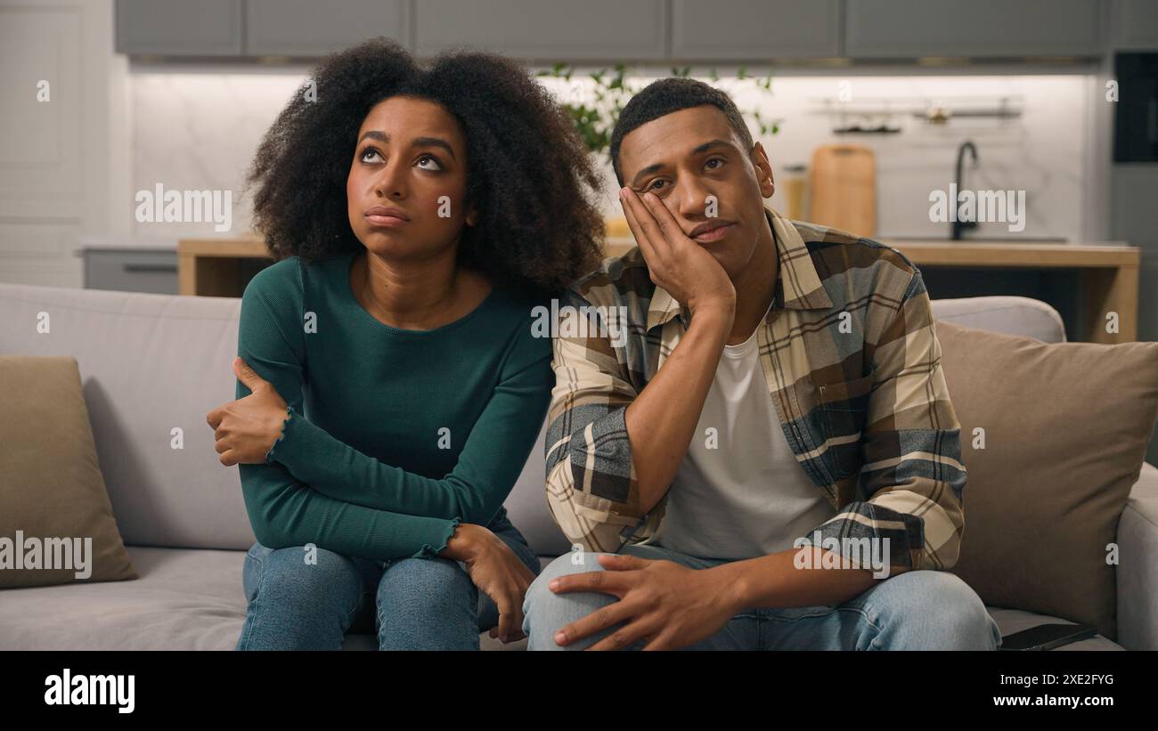 Stressed upset irritated African American ethnic parents father mother ...