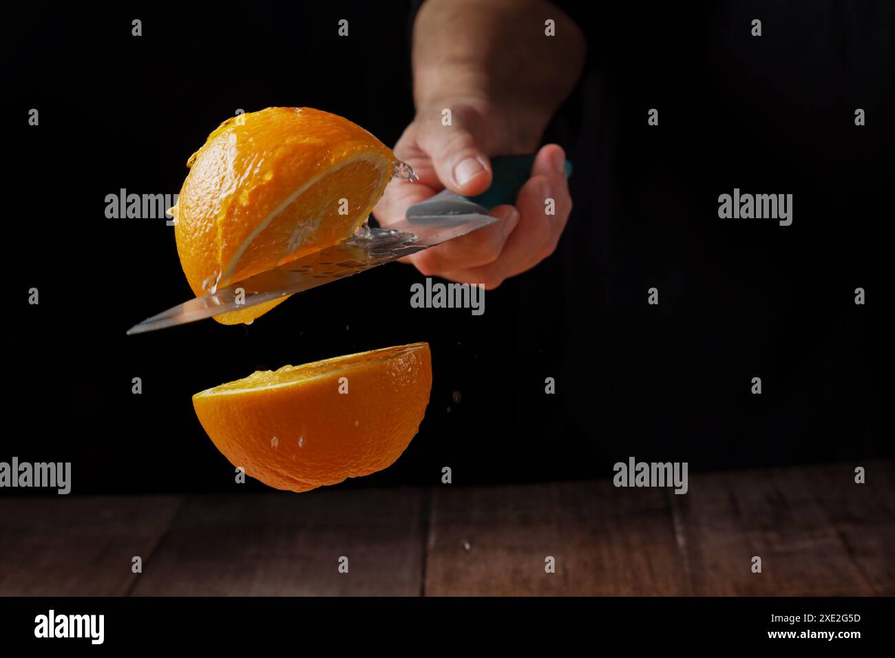 Half orange in hand hi-res stock photography and images - Alamy