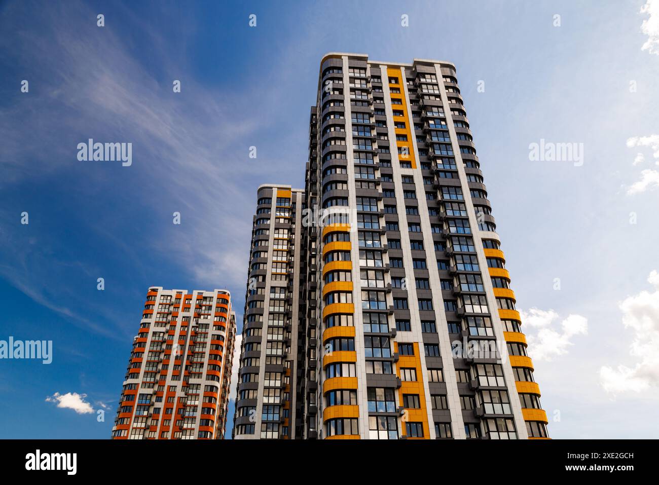 Freshly built high rise apartment buildings on blue sky background with ...