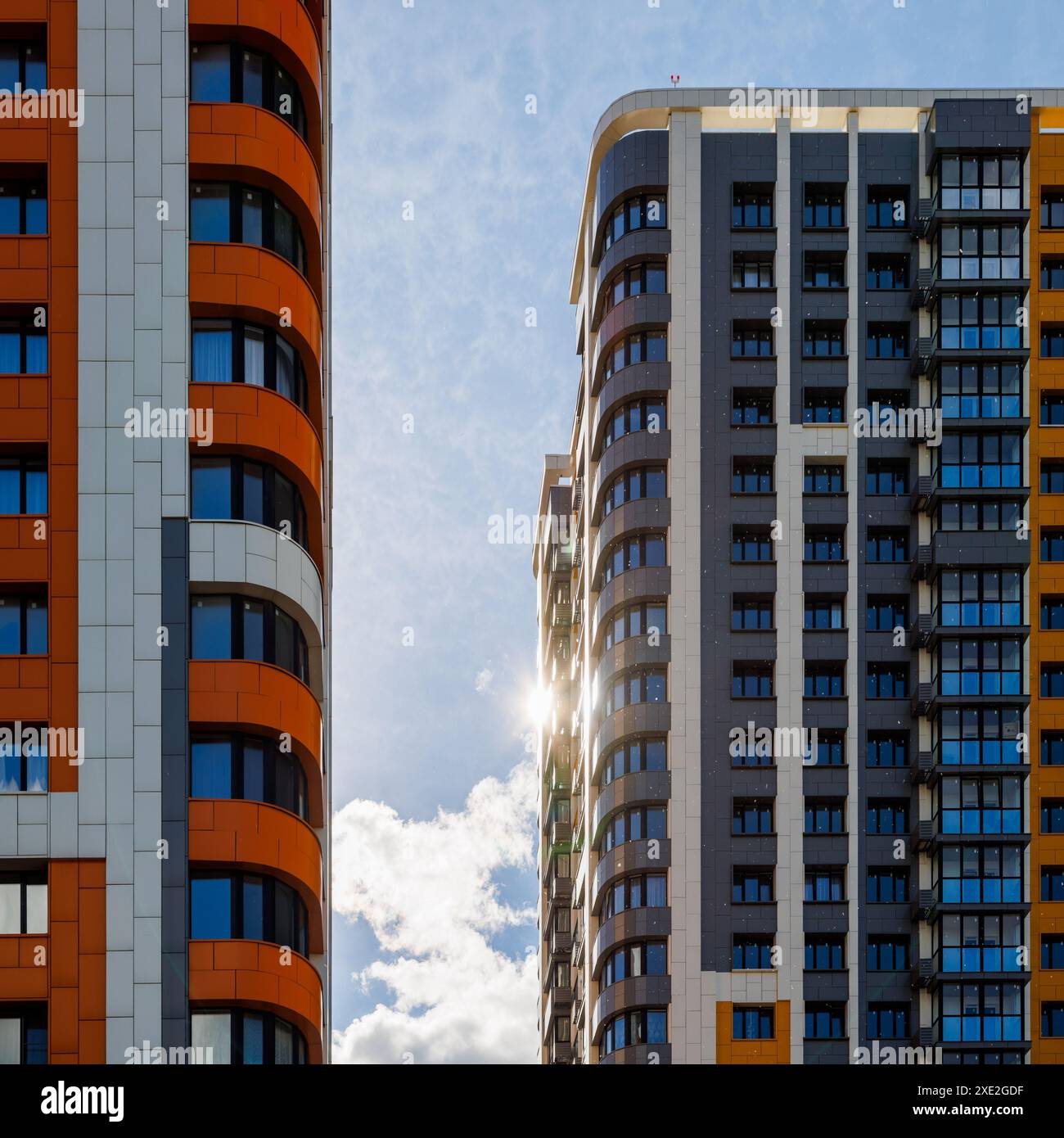 freshly built high rise apartment buildings on blue sky background with ...