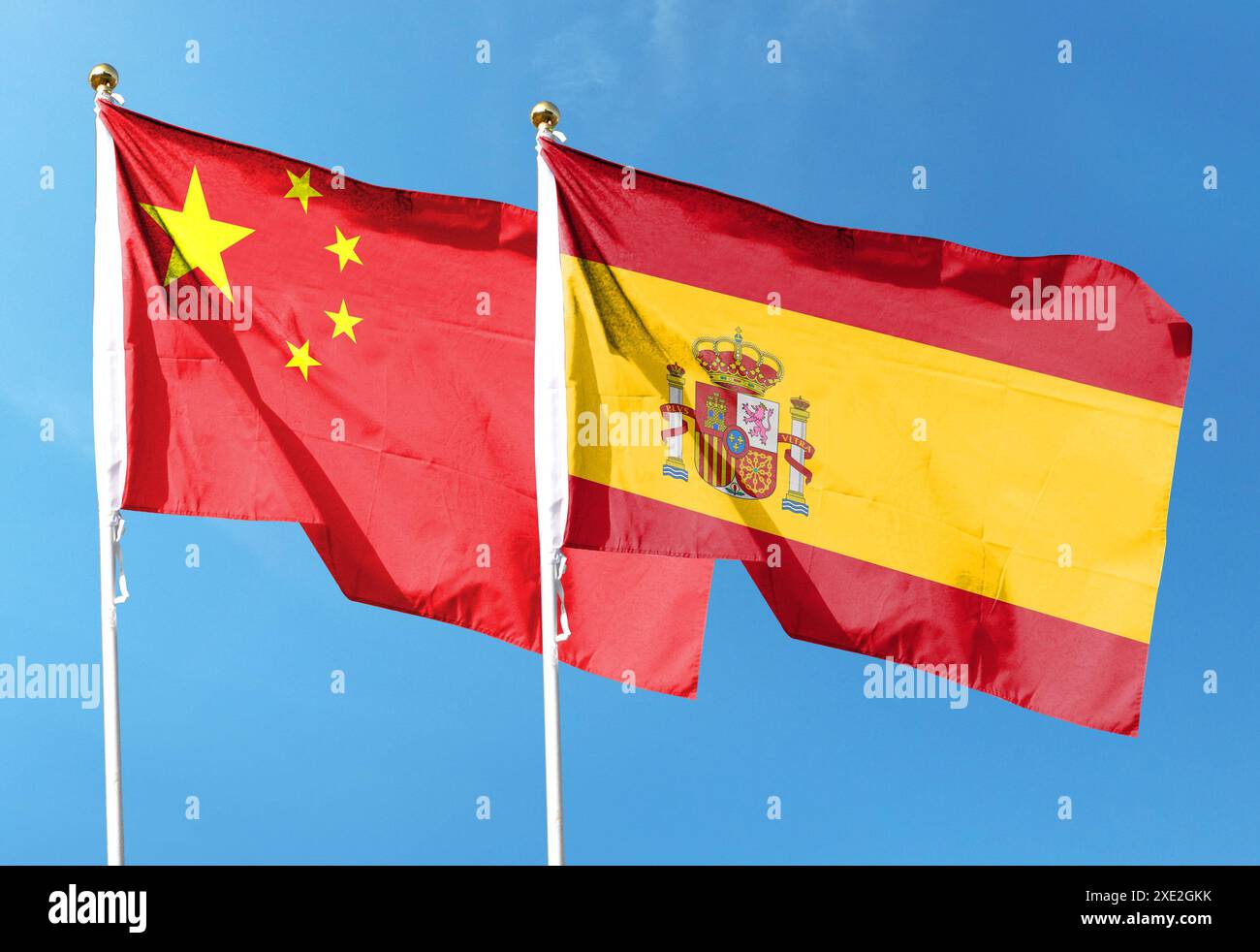 Chinese flag and Spanish flag on cloudy sky. waving in the sky Stock ...