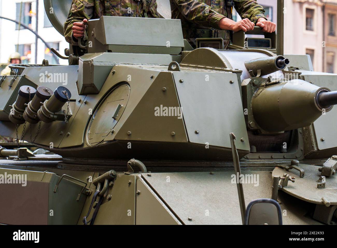 Military armored vehicle turret with two soldiers. Gun barrel and smoke ...