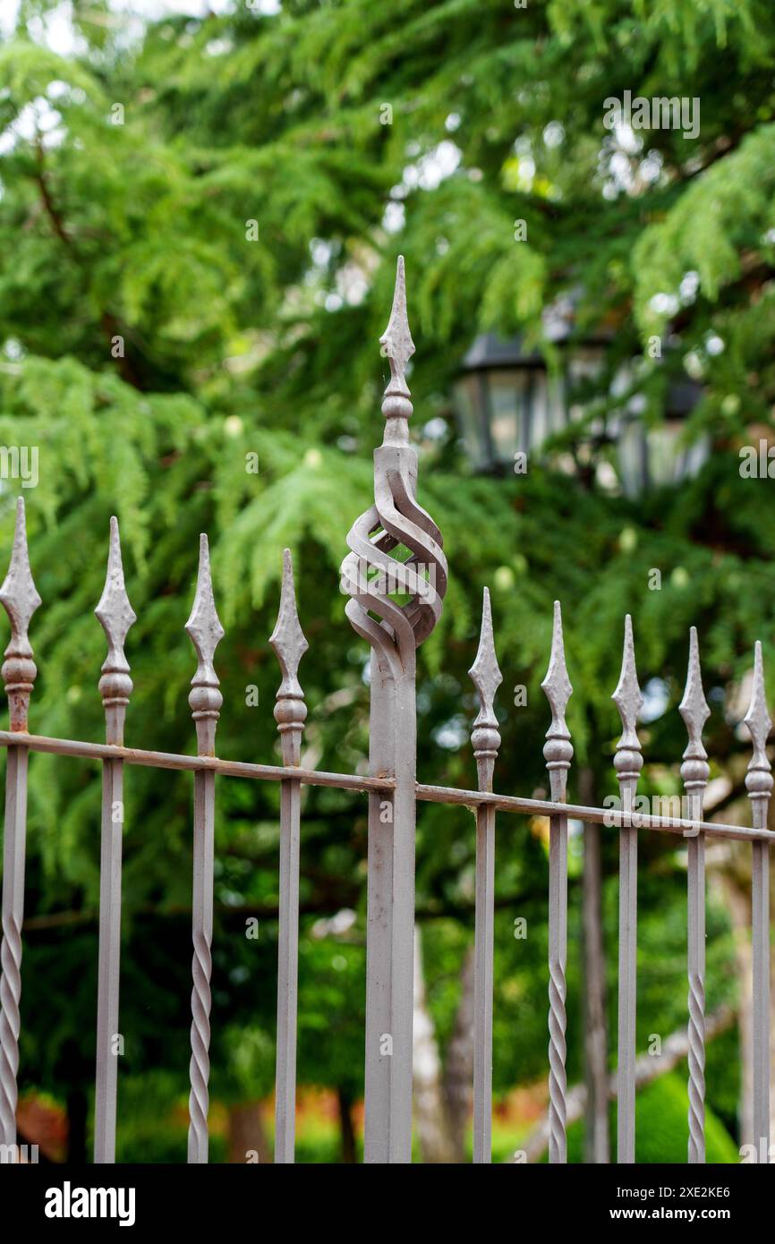Intricately designed iron fence post with a decorative twisted pattern ...