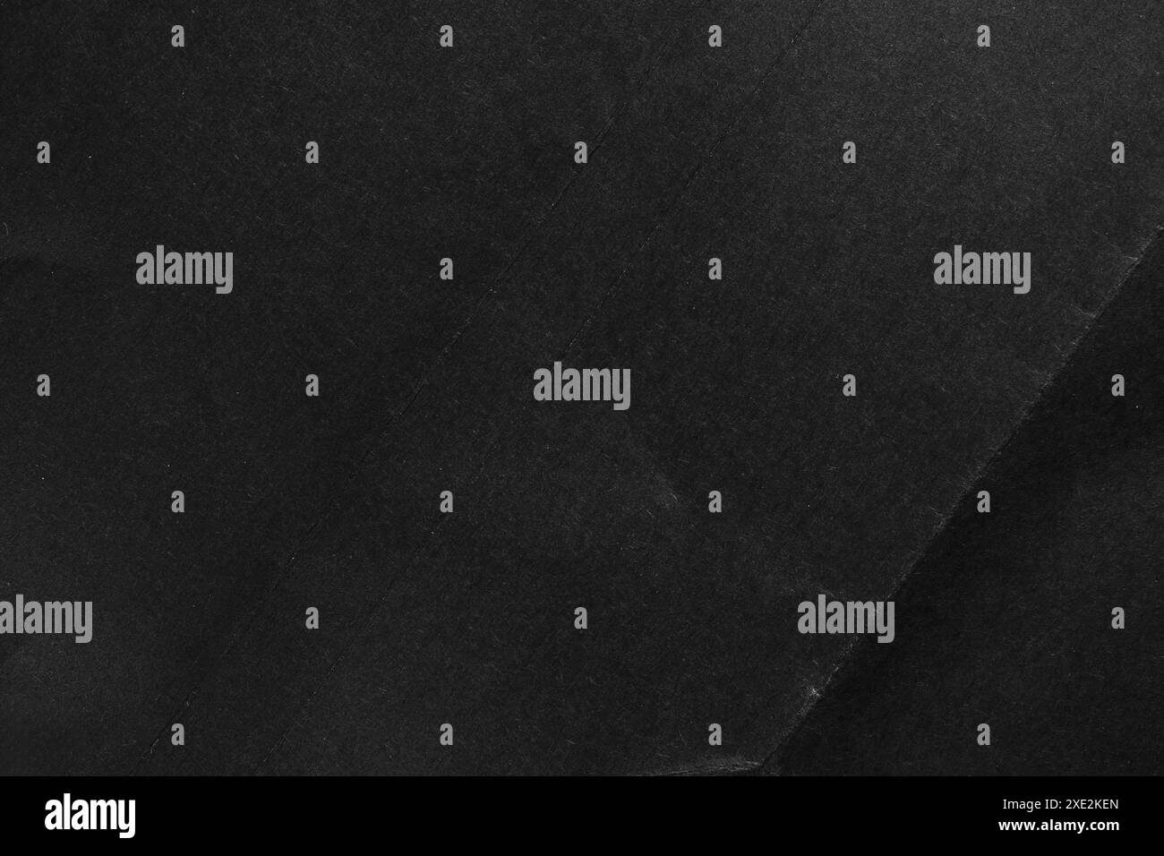 Black paper textured surface with a subtle fold and unique natural ...