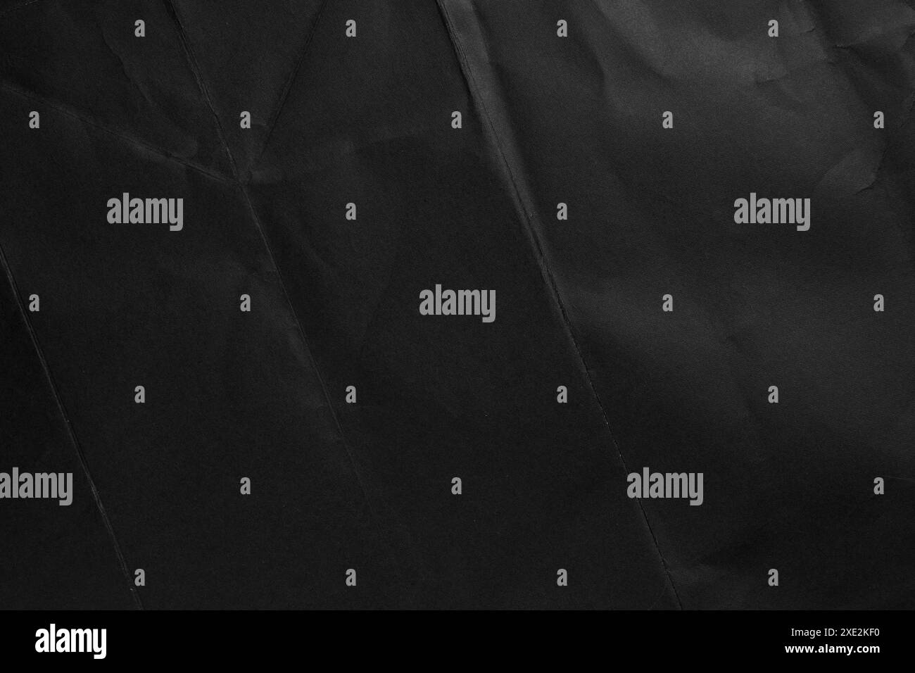 Crumpled black cardboard with intricate wrinkles and wrinkled linely ...