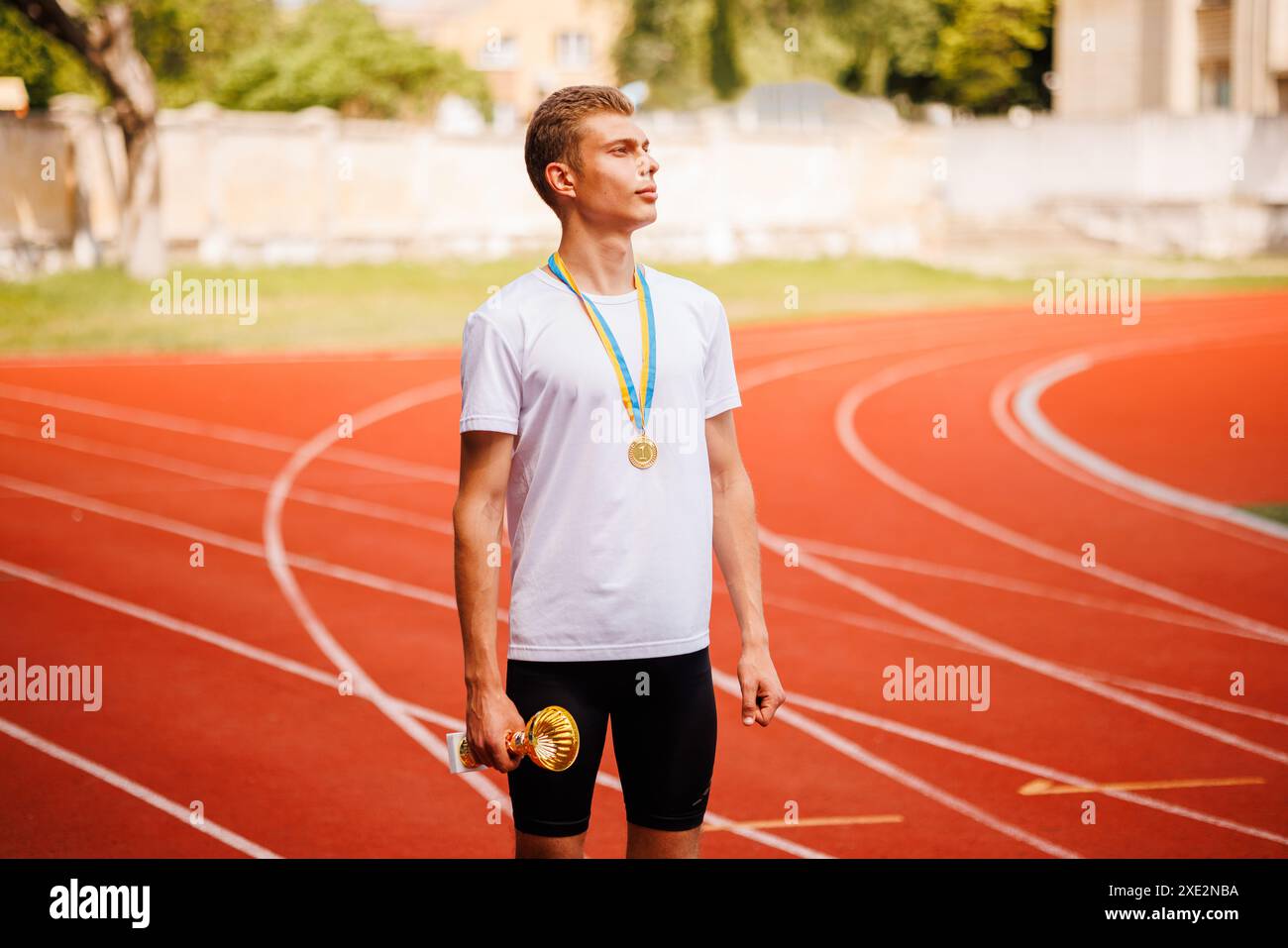 A determined athlete is in a crouched position at the starting line of ...