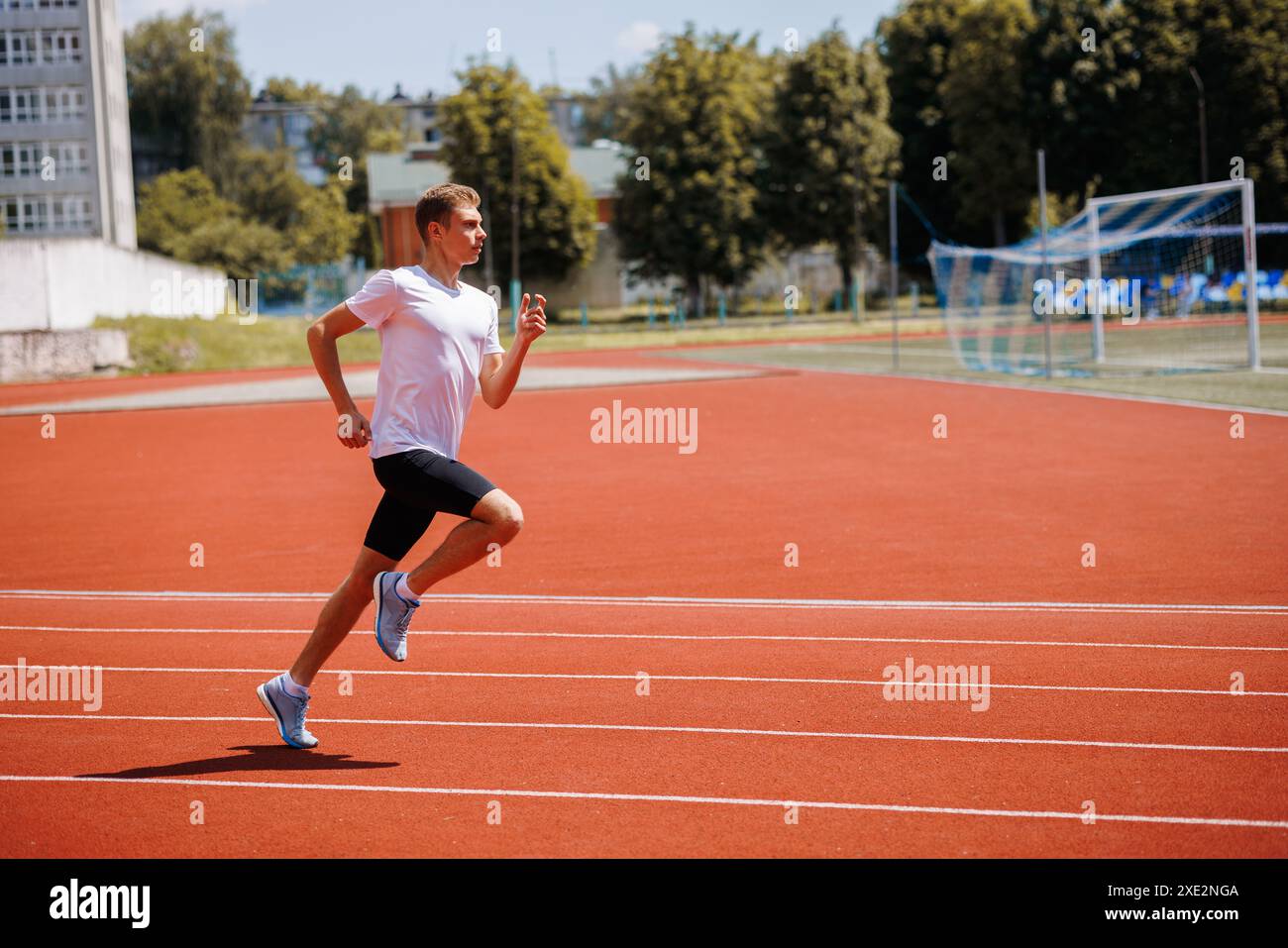 An athlete runs along a stadium track. long distance marathon runner ...
